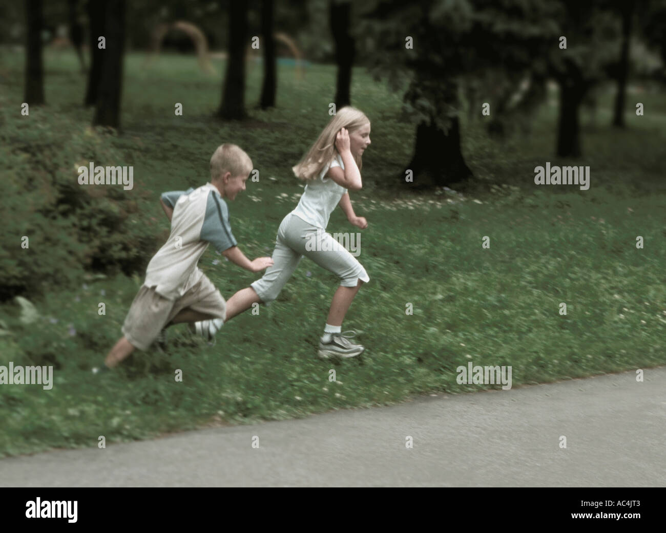 boy and girl running in park Stock Photo - Alamy