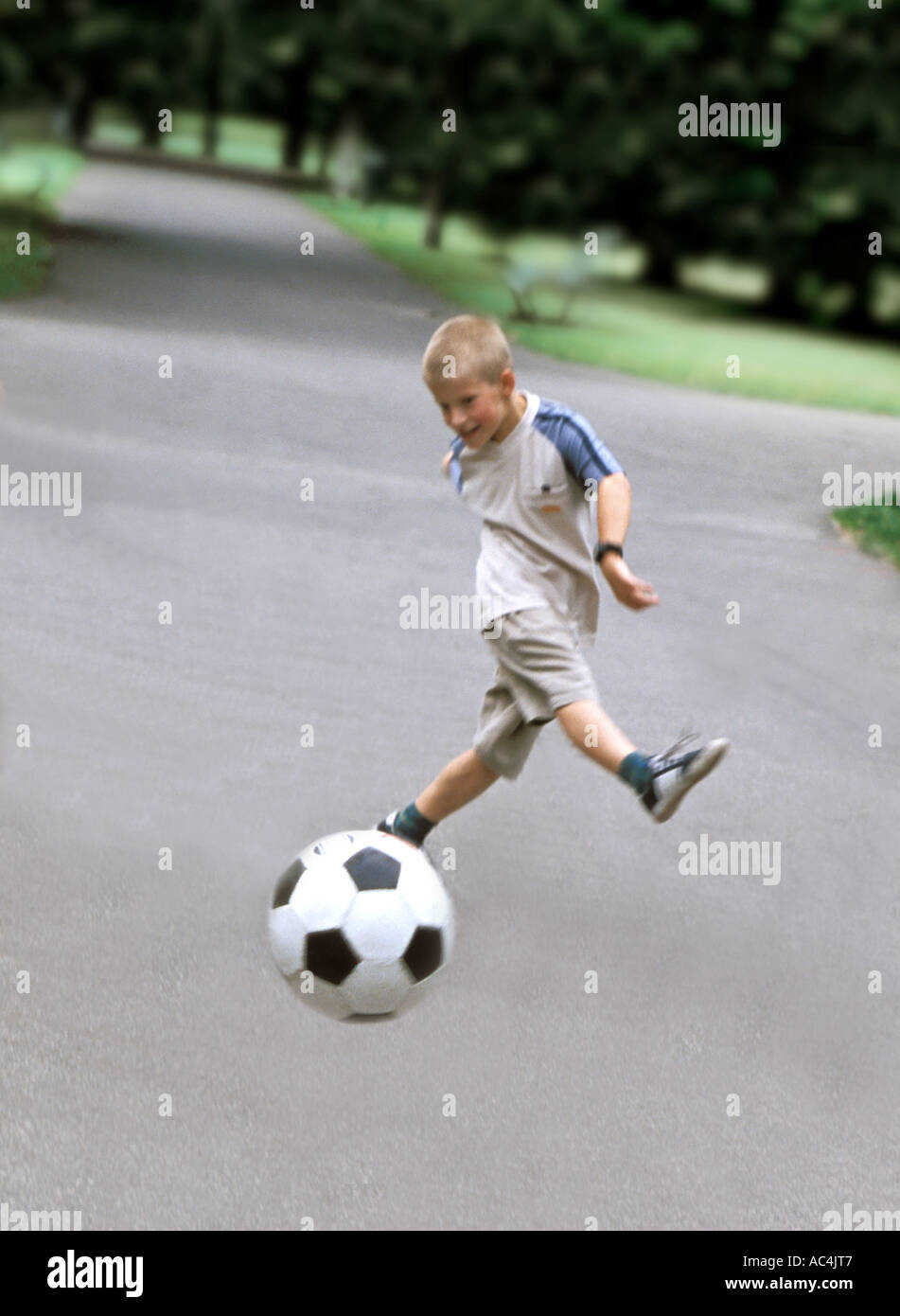 boy kicking ball Stock Photo - Alamy