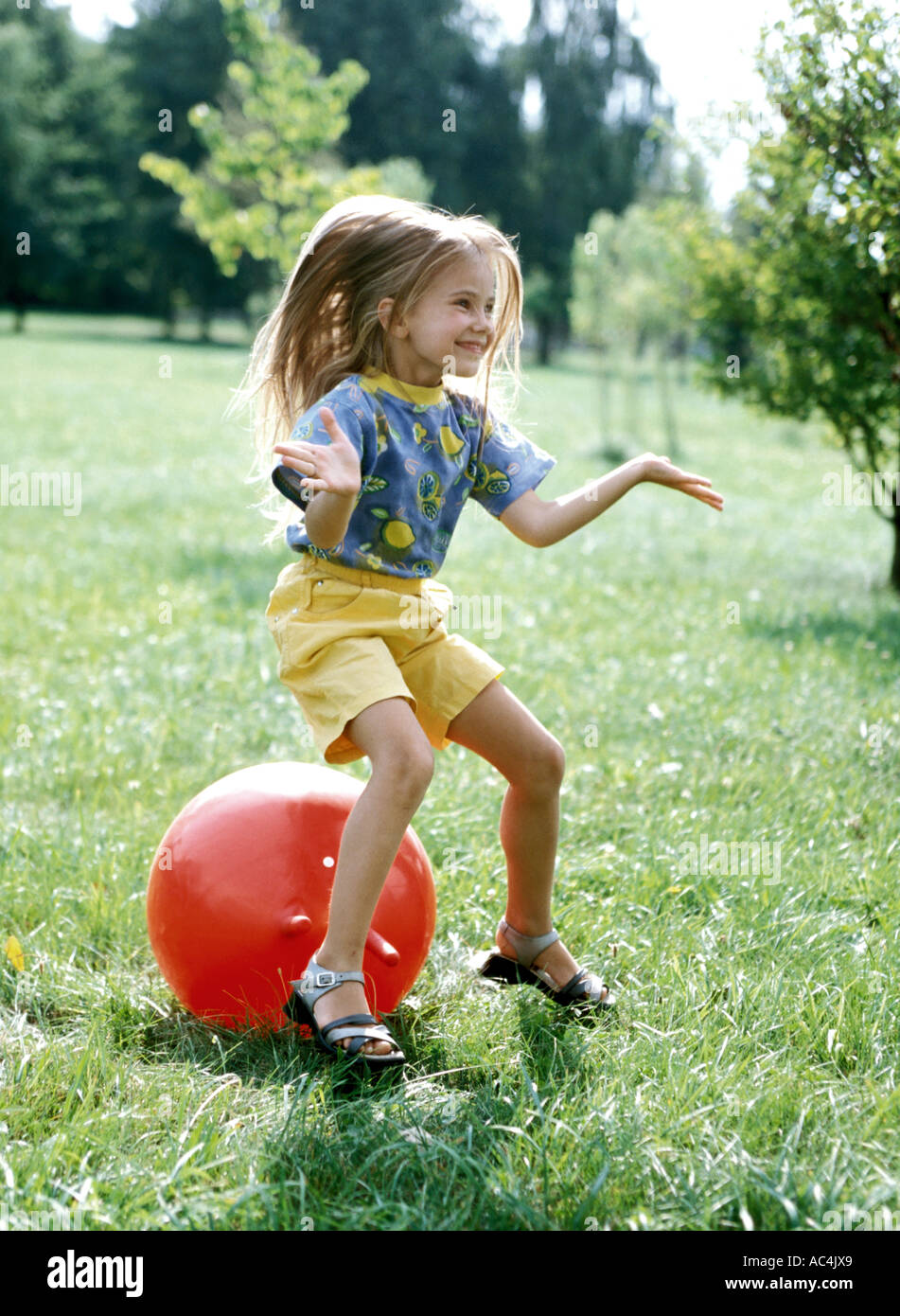 girl jumping on airball in park MR8412 Stock Photo - Alamy