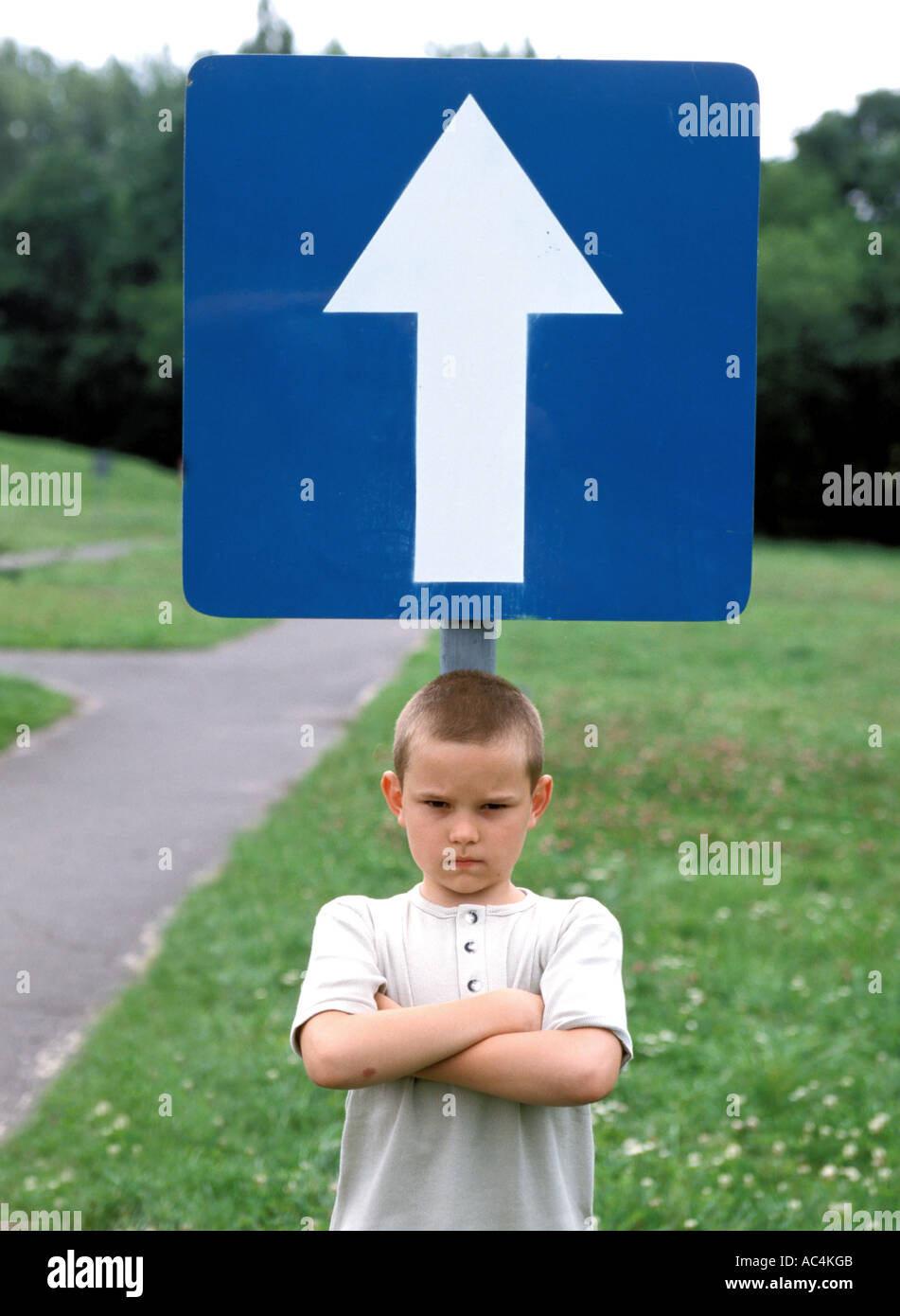 upset boy standing under forward sign Stock Photo - Alamy