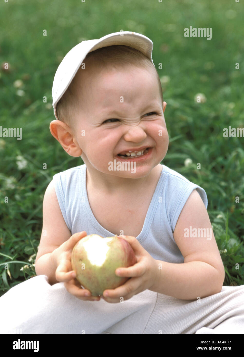 Boy eating sour apple hi-res stock photography and images - Alamy