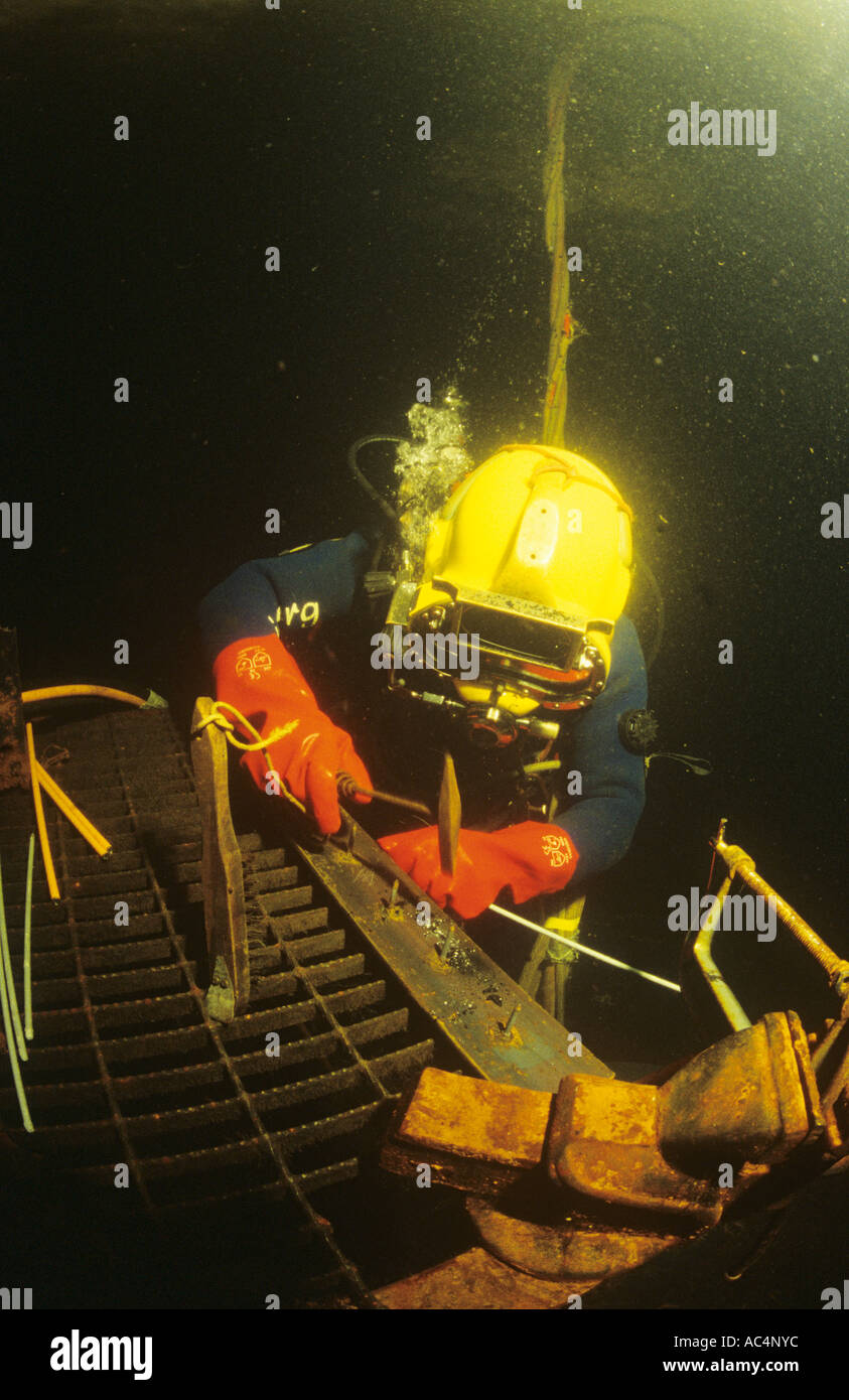 Commercial diver working underwater welding with an oxygen lance Stock ...