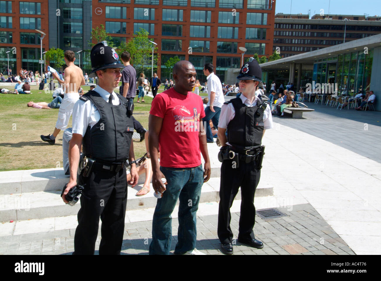 Two Police men in uniform pose with Afro Caribbean man Piccadilly ...