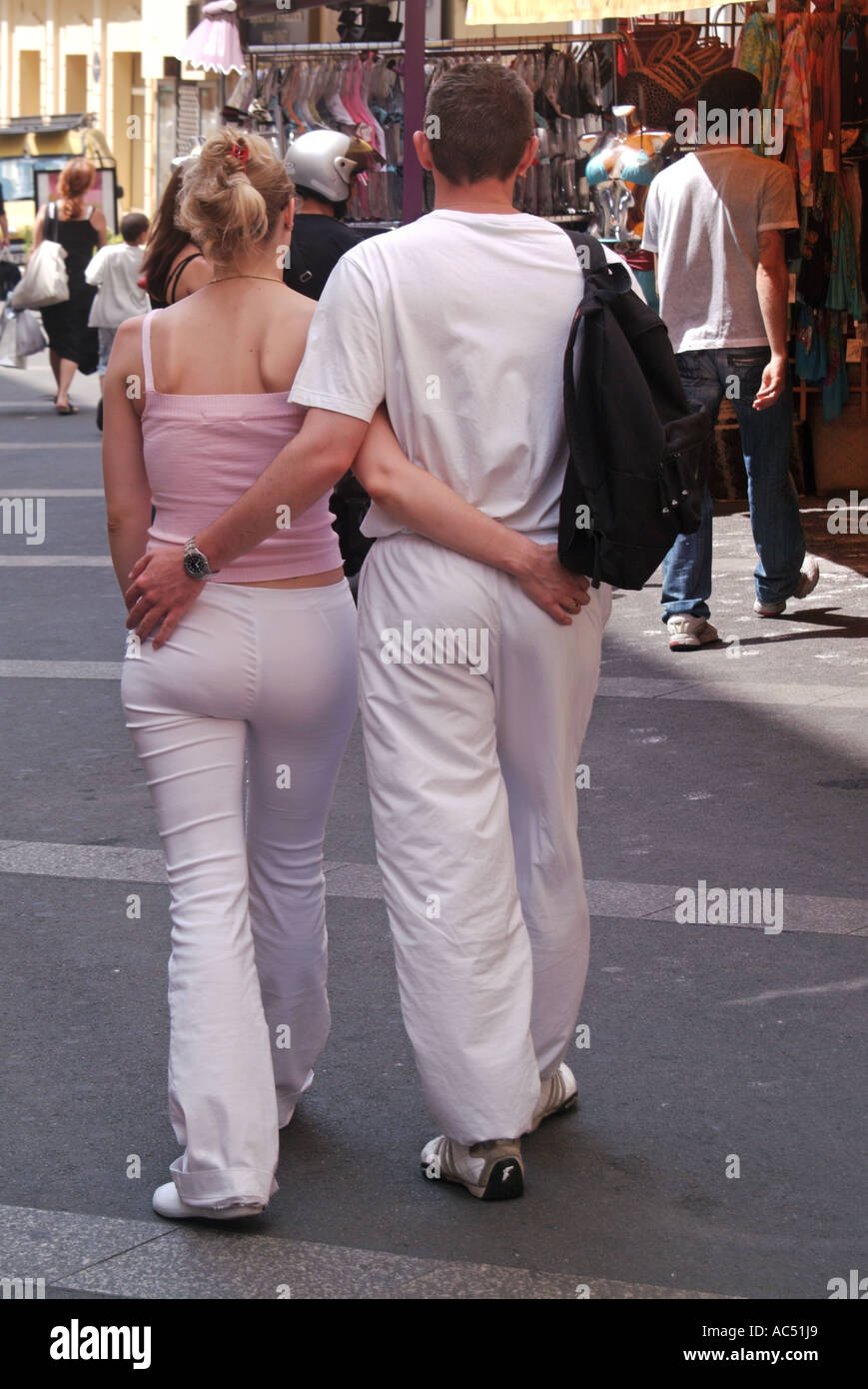 Couple arm shoulder walking hi-res stock photography and images - Alamy