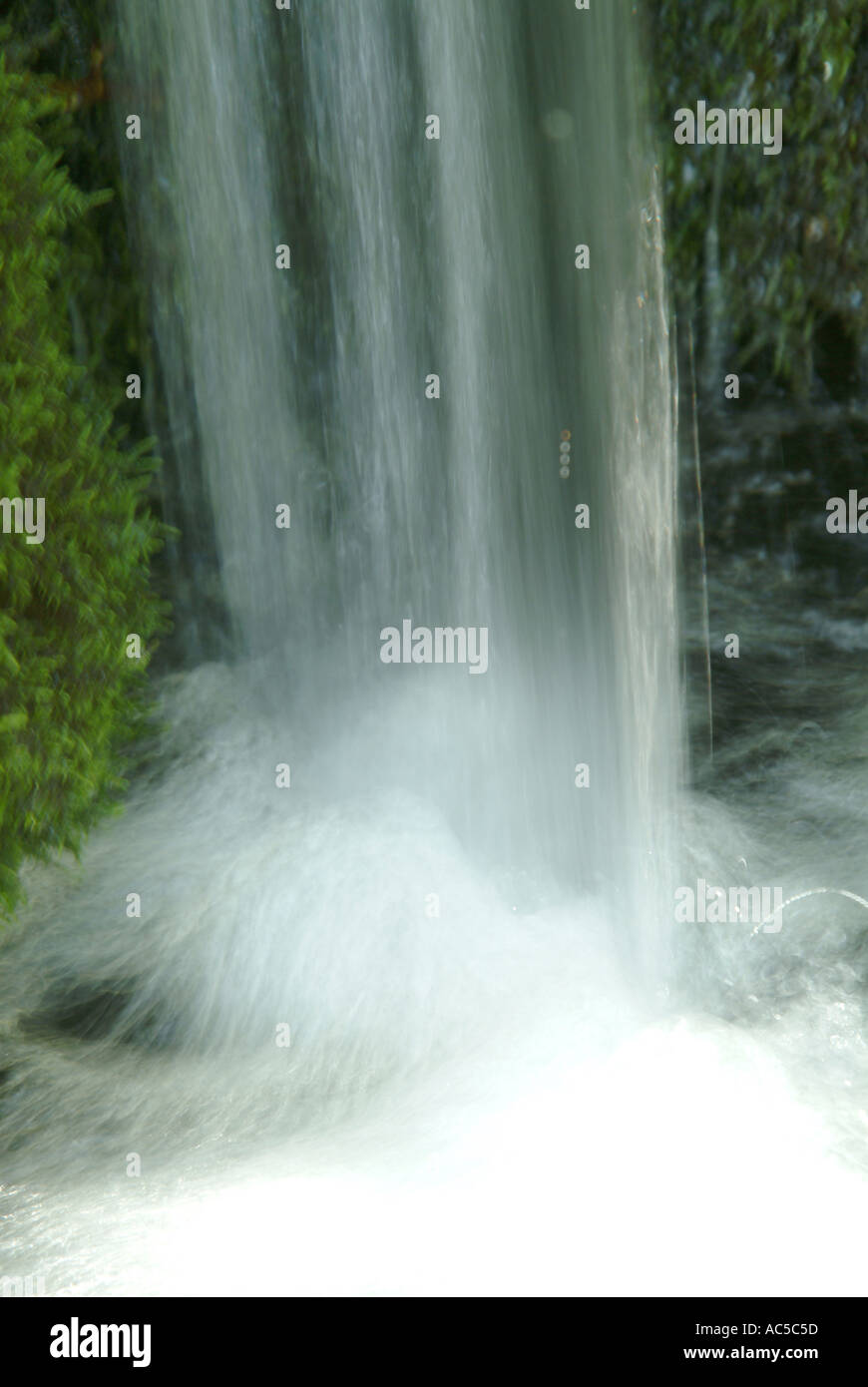 spring water falling down into trough Compton Abdale Cotswolds ...