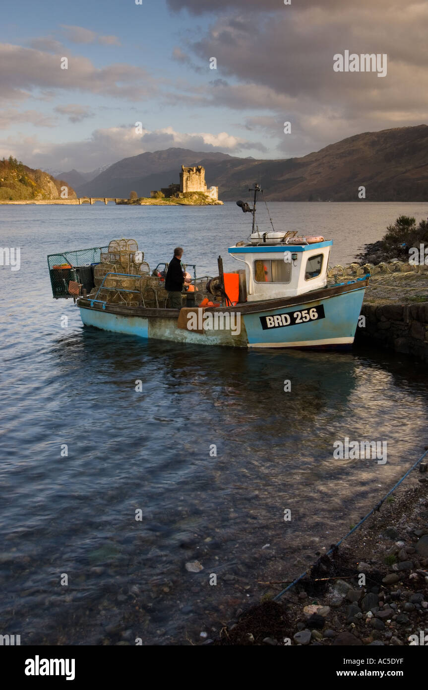 Fisherman and boat Eilean Donan Castle Loch Duich Scotland UK Stock ...