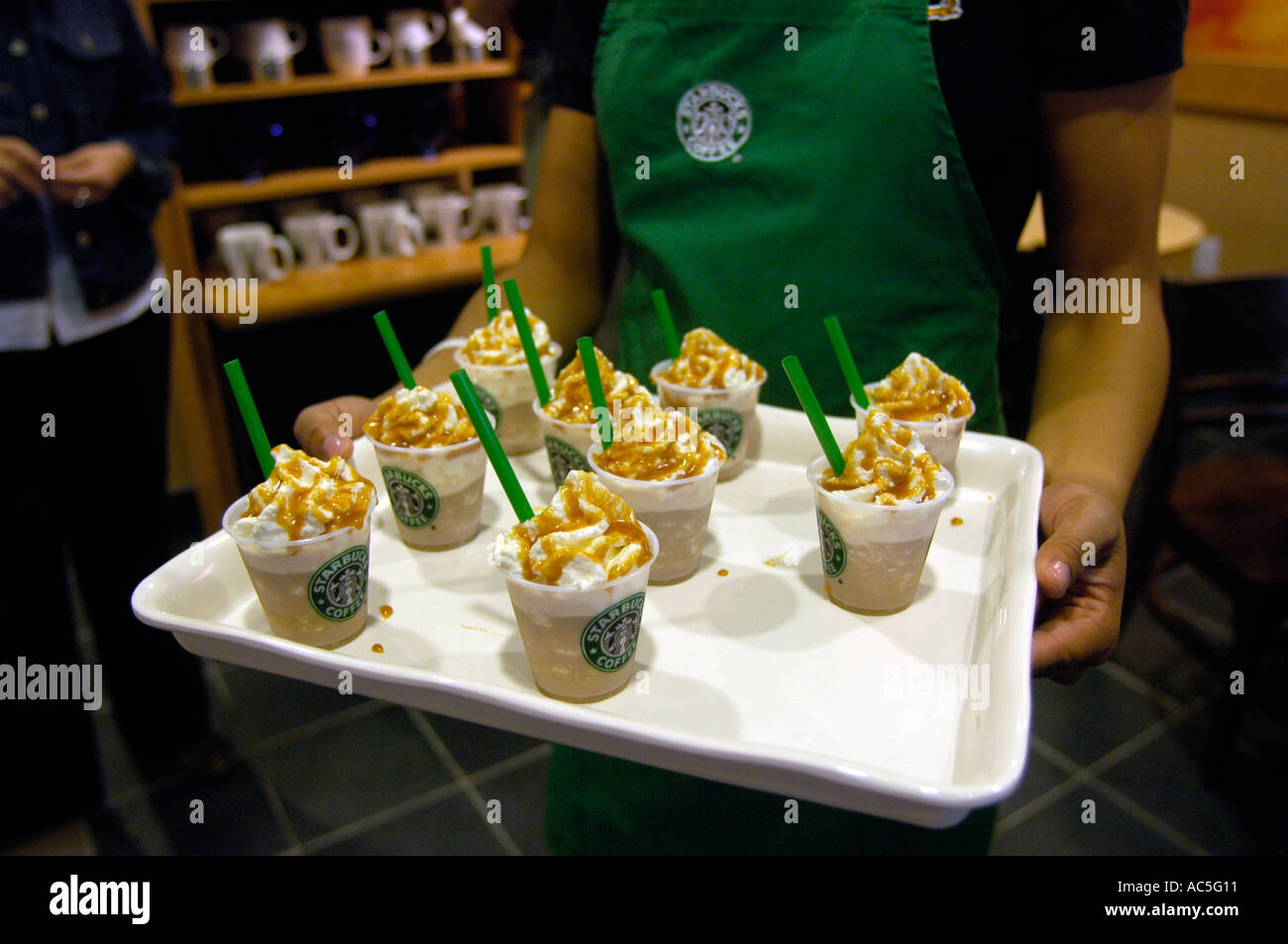 Starbucks employees distribute free Frappuccino samples Stock Photo - Alamy