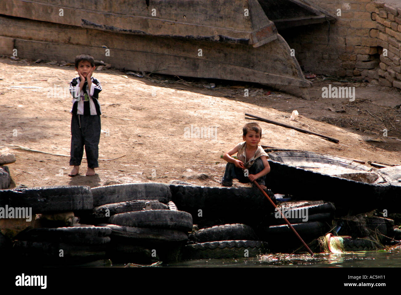 Iraq Basra Life in 2005 A young child holds his face in his hands as he ...