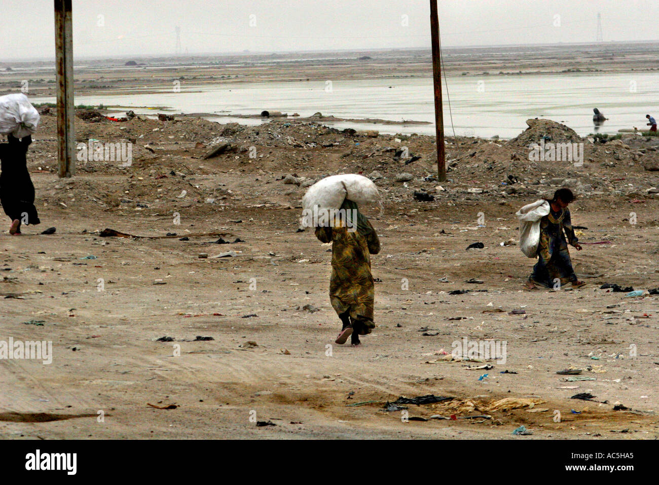 Iraq basra Life 2005 Young girls struggle under the weight of big bags ...