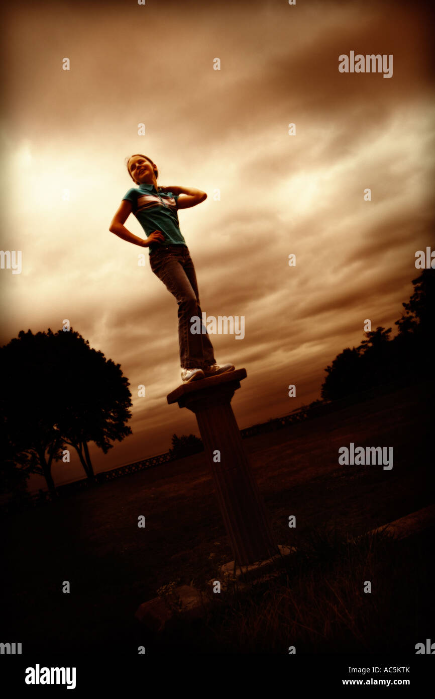 beautiful young girl smiling standing on a pedestal like a statue ...