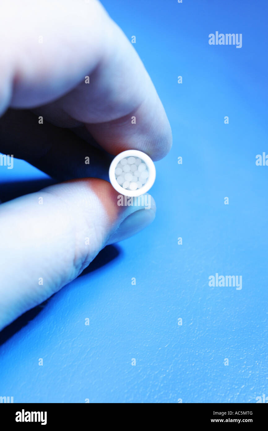 Opened homeopathic capsule Stock Photo - Alamy