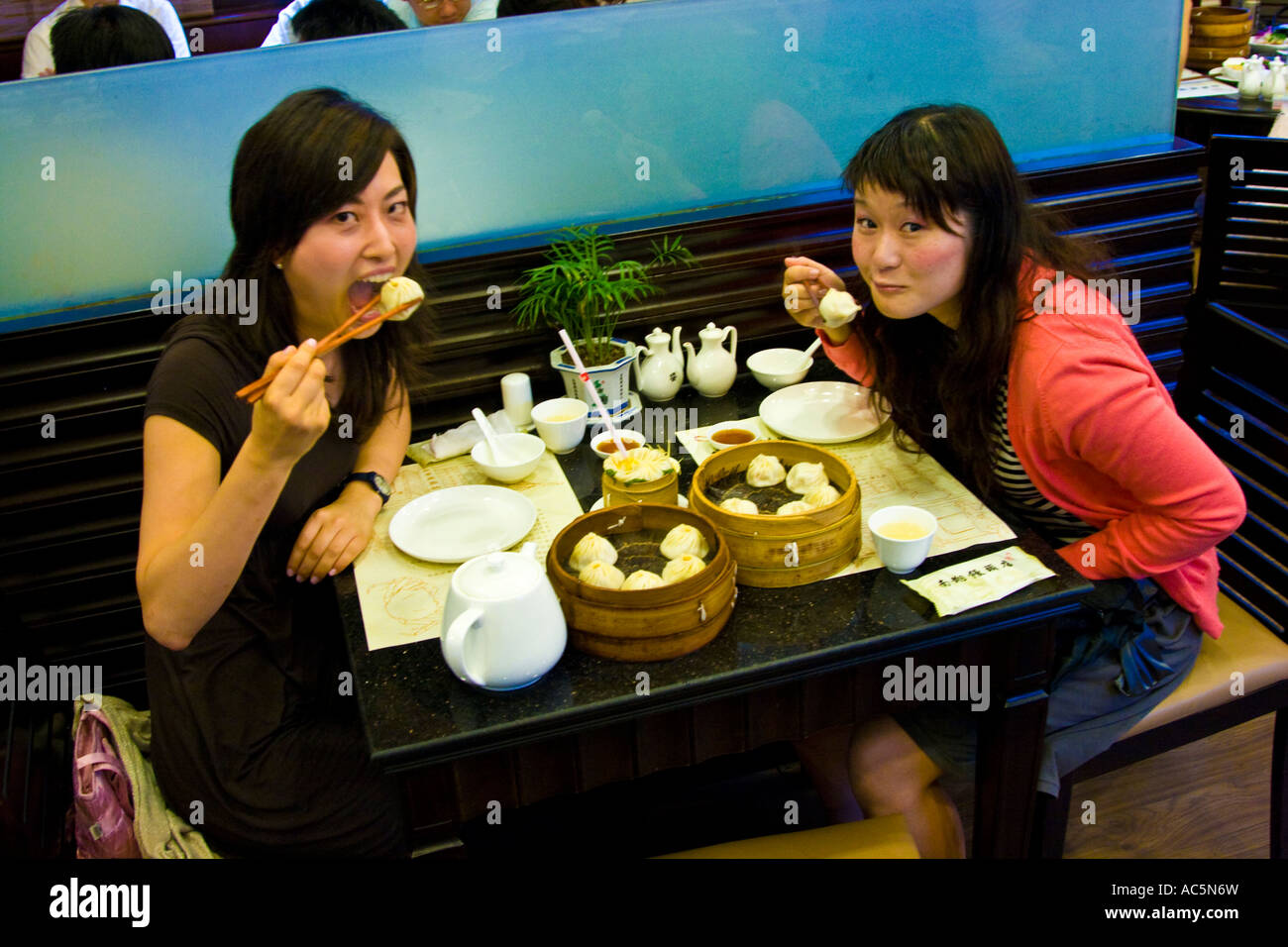 Two Young Chinese Women enjoying Nanxiang Dumpling House Yuyuan Bazaar ...