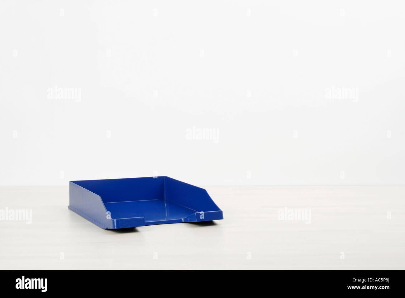 Filing tray on desk blue close up Stock Photo - Alamy