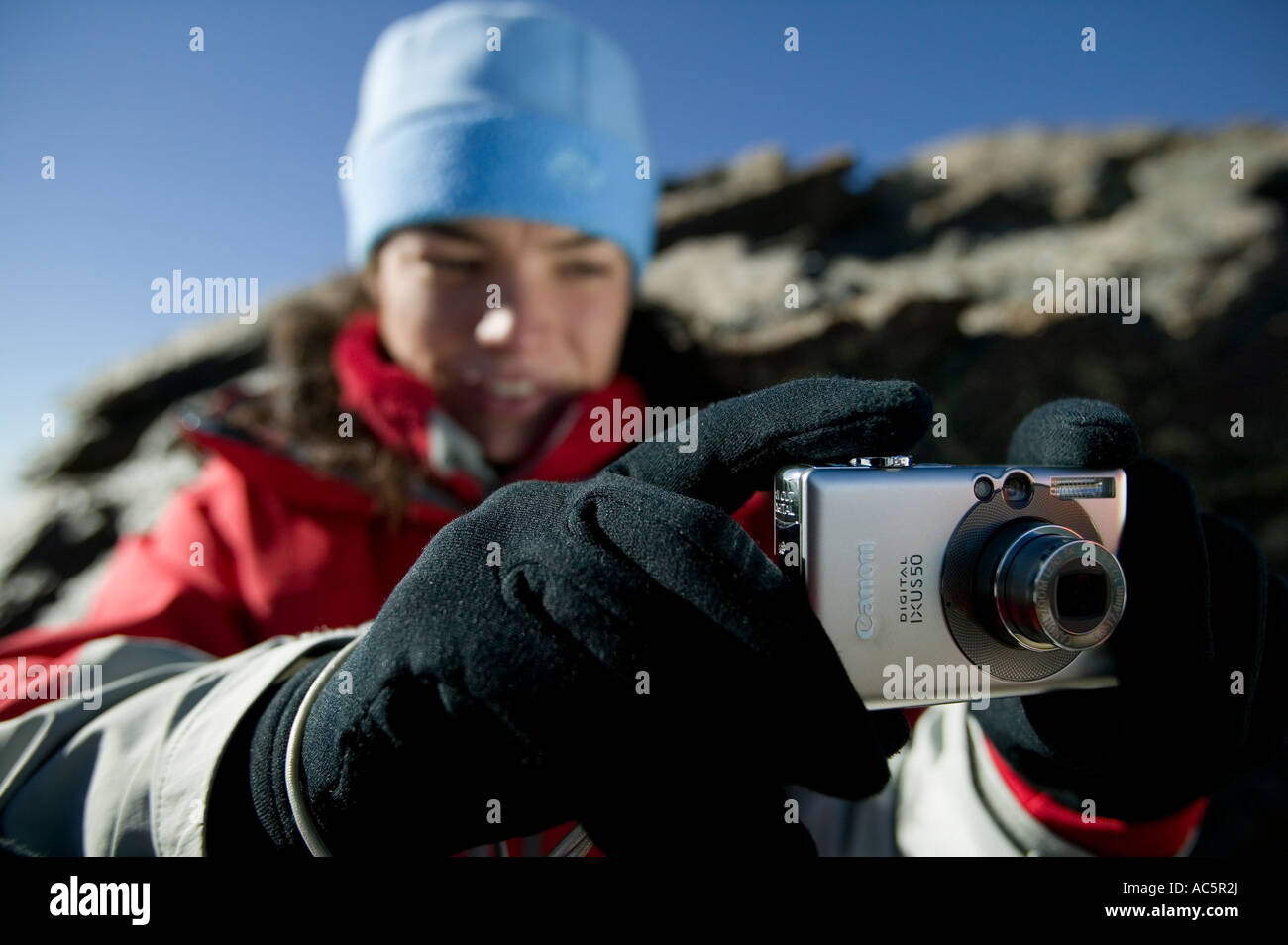 Woman using compact digital camera in mountains Stock Photo - Alamy