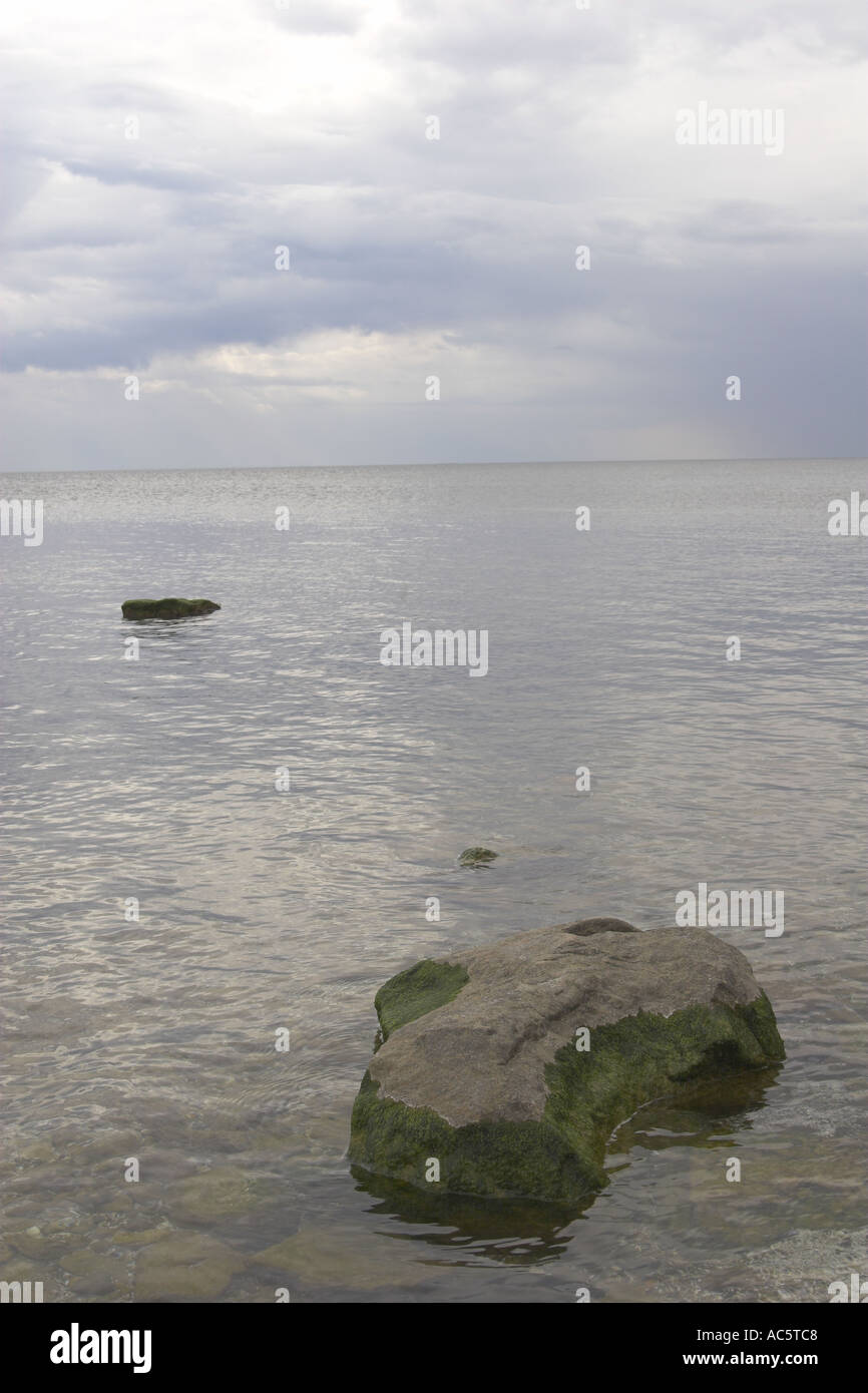 Vertical view of rocks in water Stock Photo - Alamy