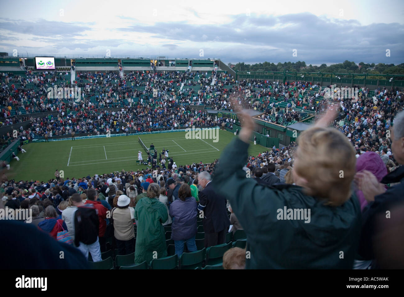 Woman spectator clapping close of play at Centre Court Wimbledon tennis ...