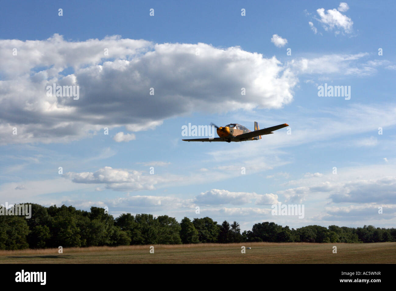 A private plane in World War II markings making a low pass over the ...