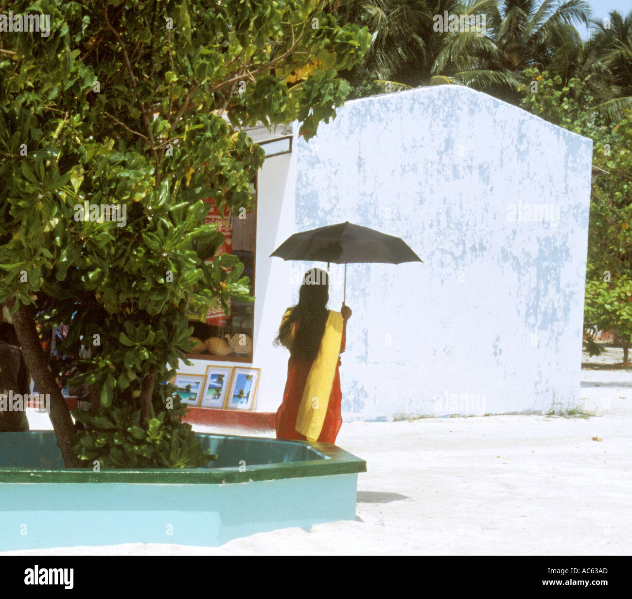 Maldivian lady taking shade Huraa island Maldives Stock Photo - Alamy