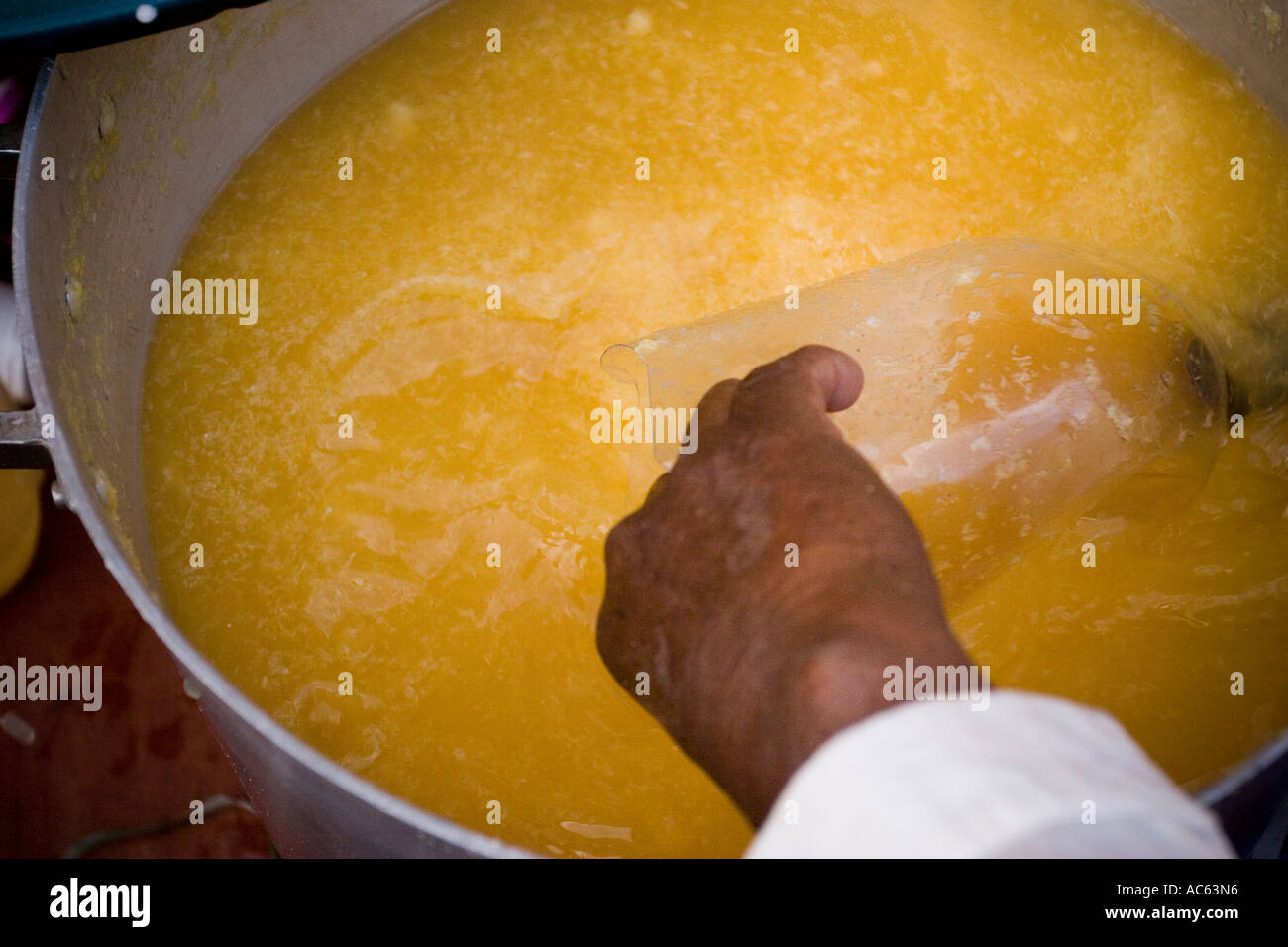 Someone picking up some chicha to drink during carnival celebration in ...