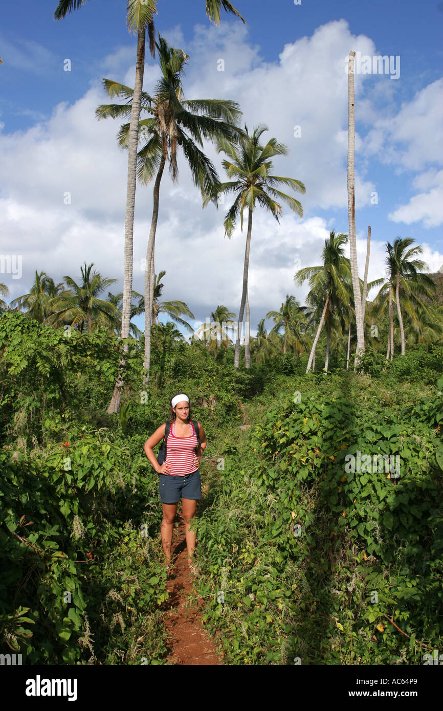 YOUNG WOMAN EXPLORER EXPLORING TREKKING IN THE JUNGLE FOREST A young ...