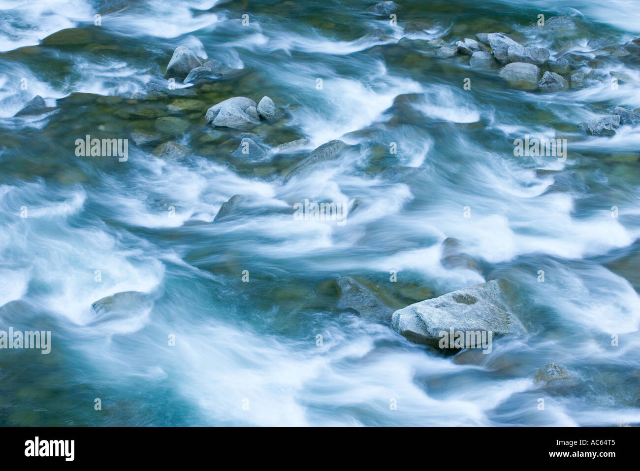 Detail of flowing river water over rocks Stock Photo - Alamy