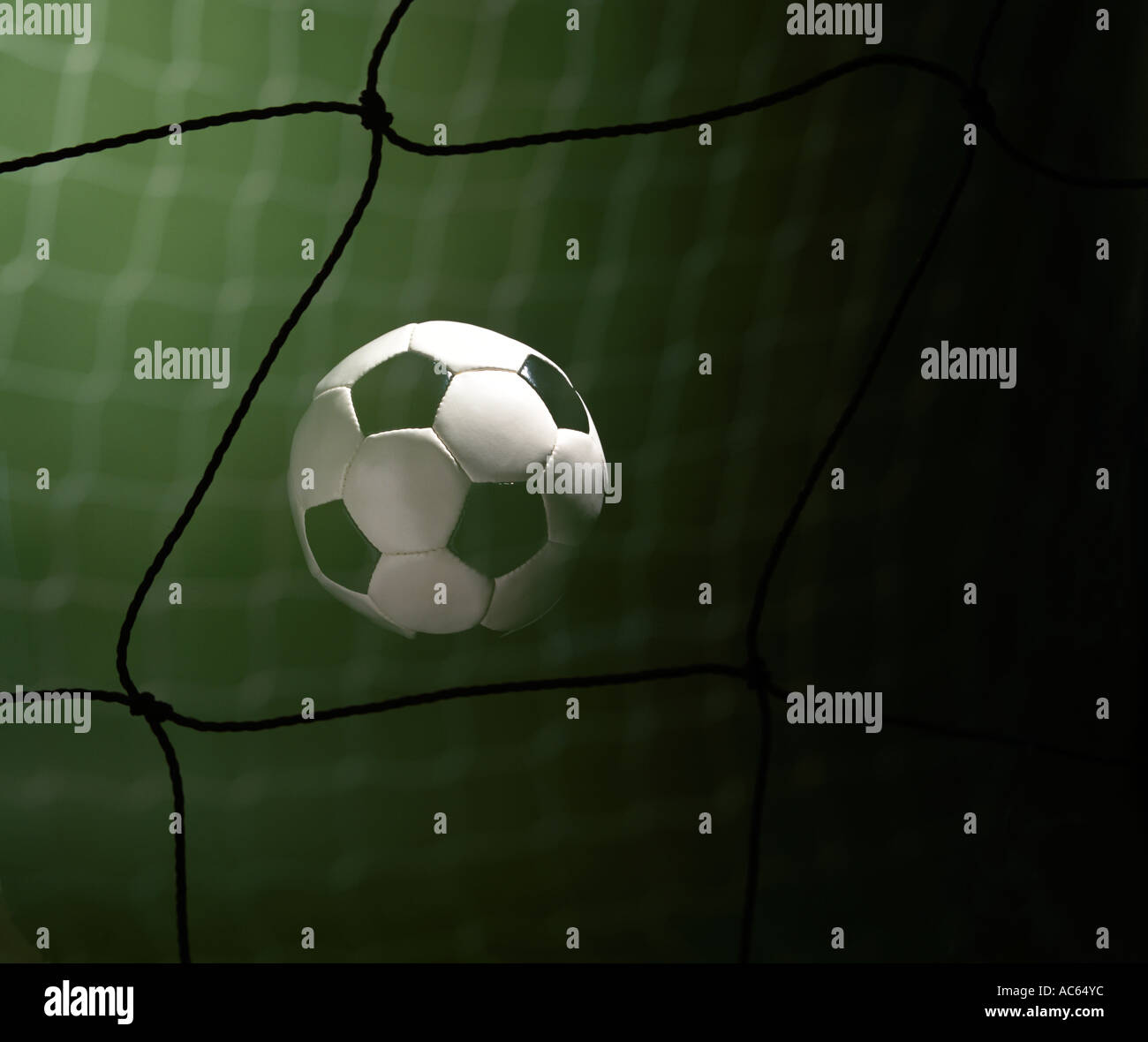 Football in the air with net on green background with ball studio still ...