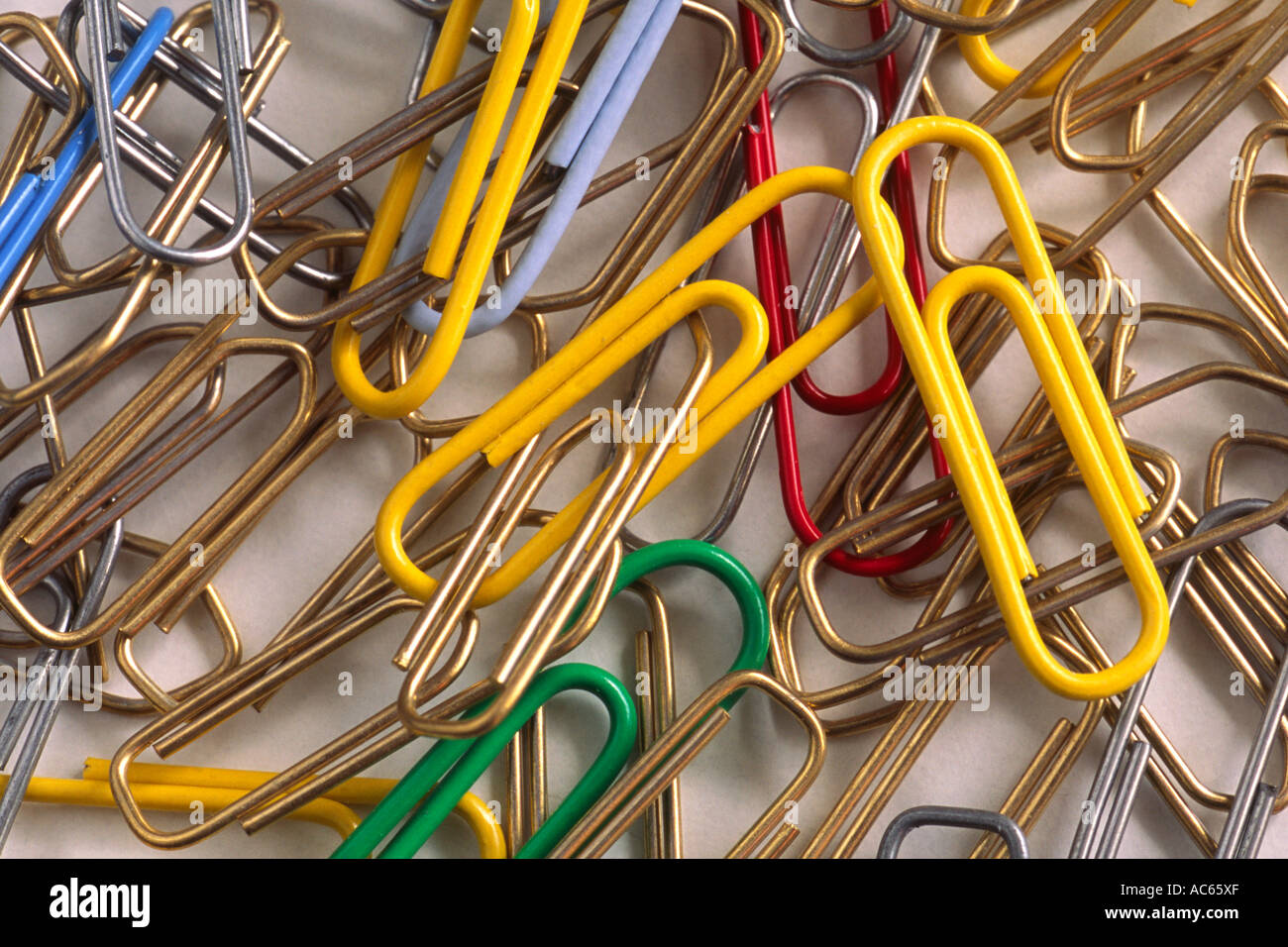 Coloured paper clips against white background Stock Photo - Alamy