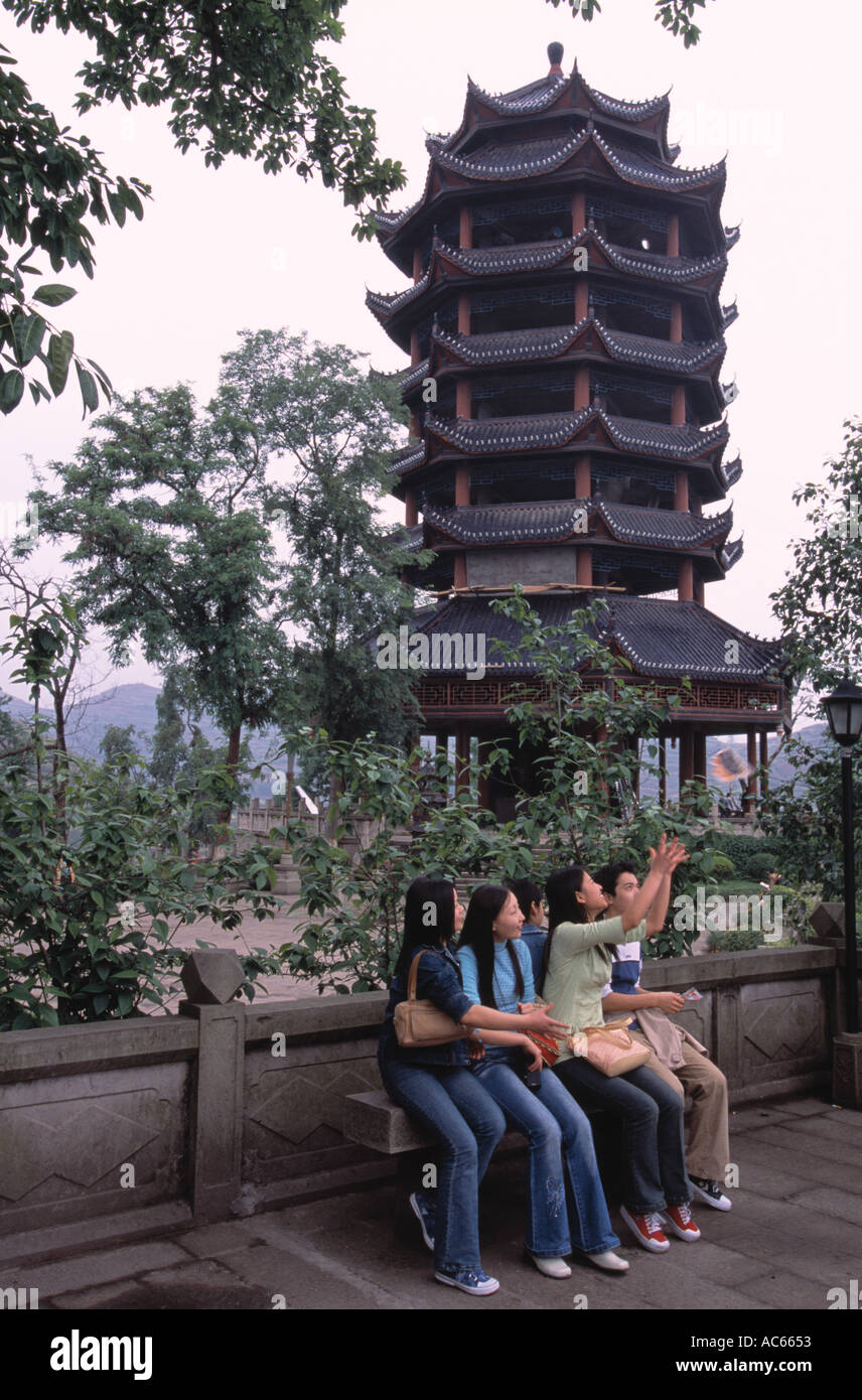 Chinese teens seated below a pagoda in the Ming Shan temple of old ...