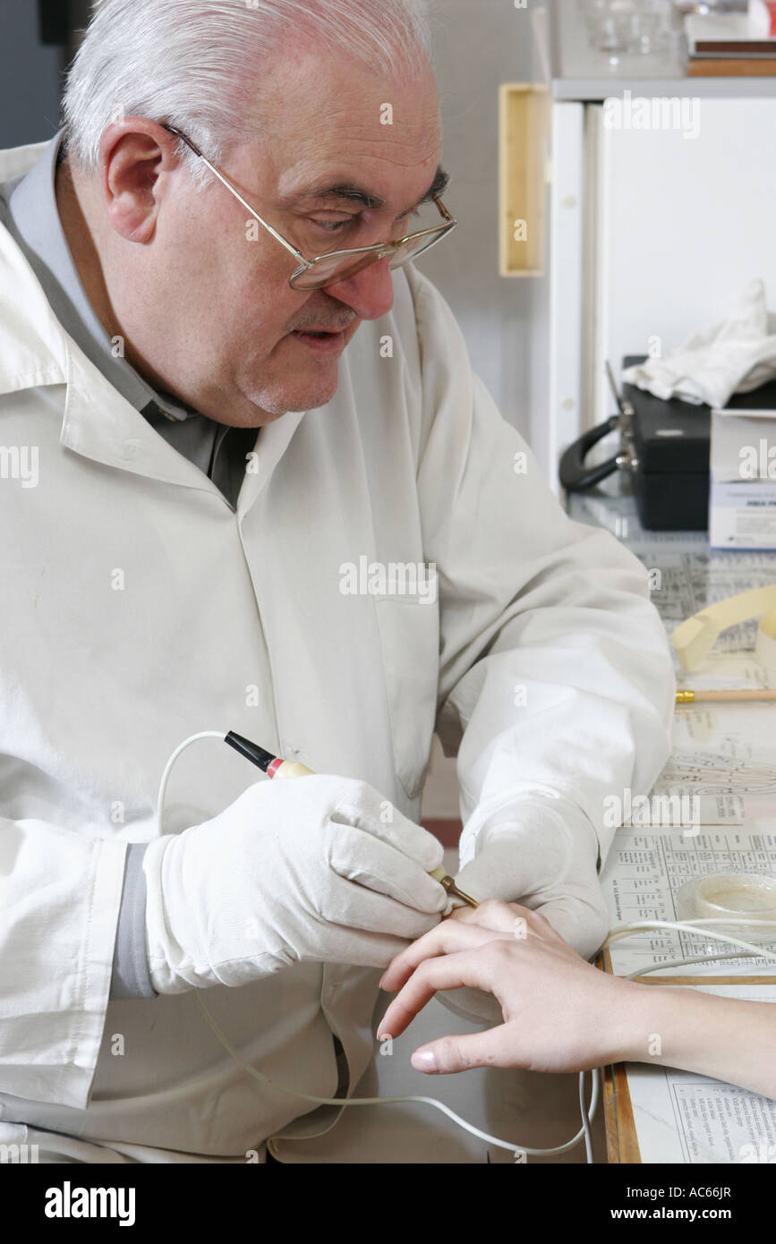 Measuring acupoints impedance by EAV L instrument Stock Photo - Alamy