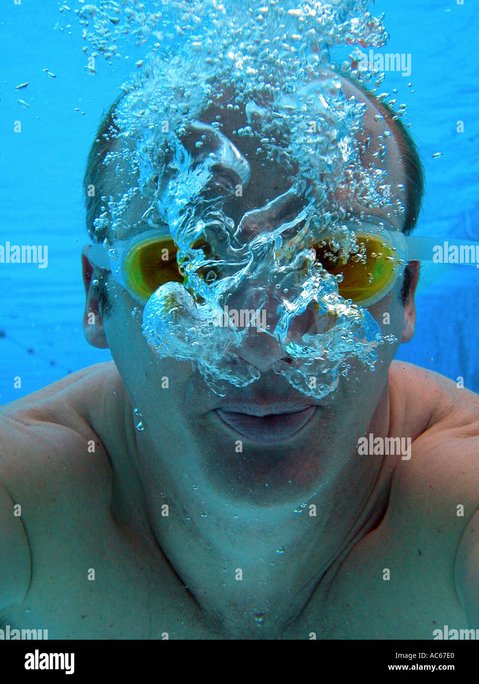 Swimmer blowing bubbles under water Stock Photo - Alamy