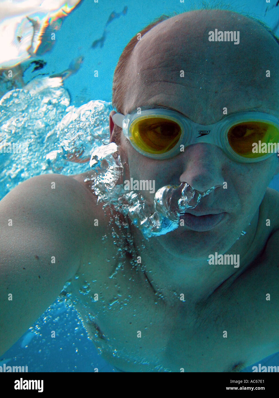 Swimmer blowing bubbles under water Stock Photo - Alamy