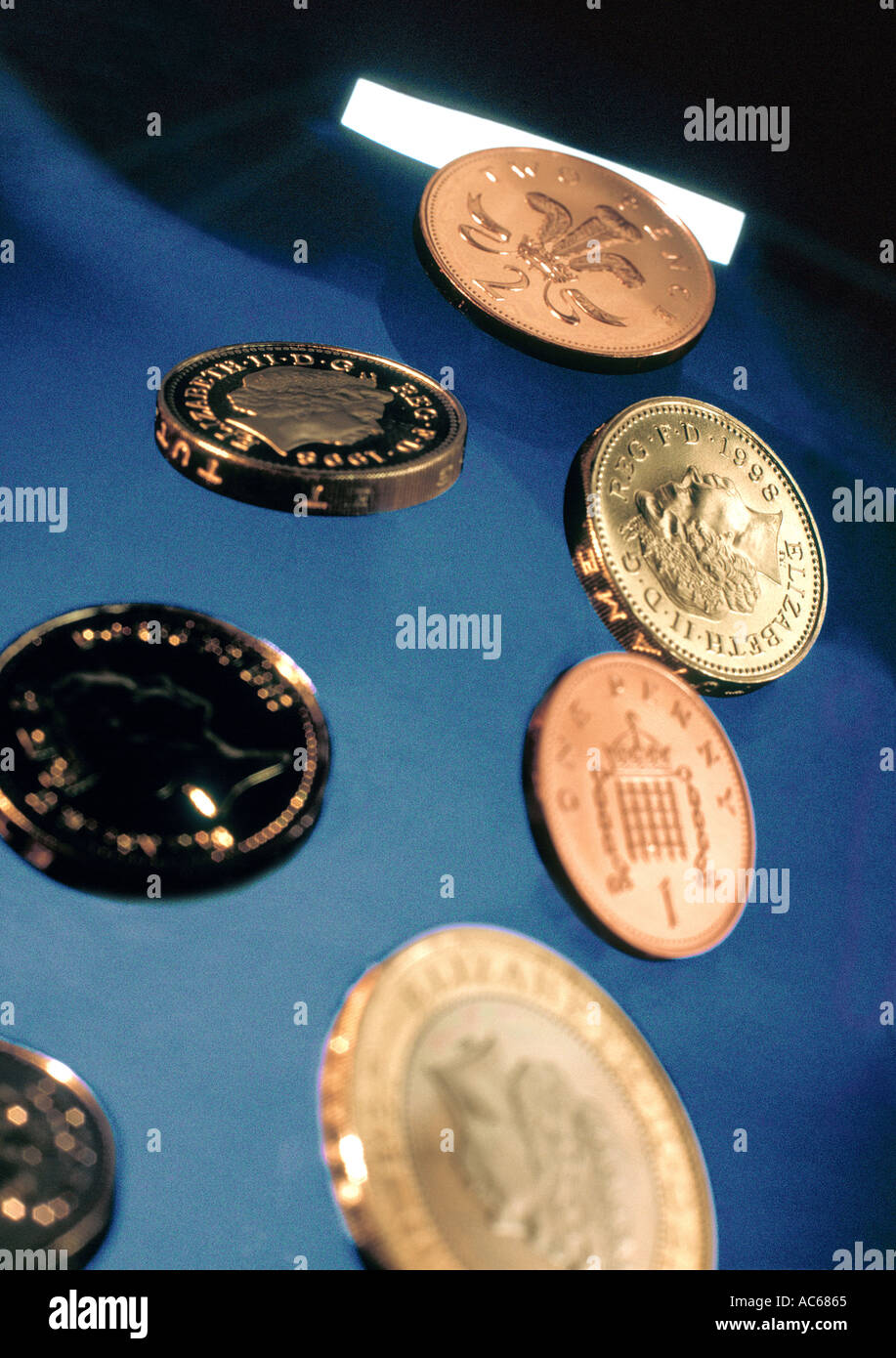 Falling UK Coins in money box Stock Photo - Alamy