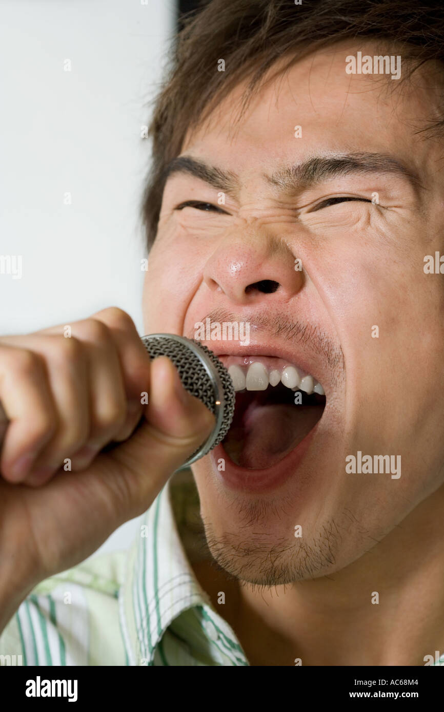 young man sings on microphone in record store Stock Photo - Alamy