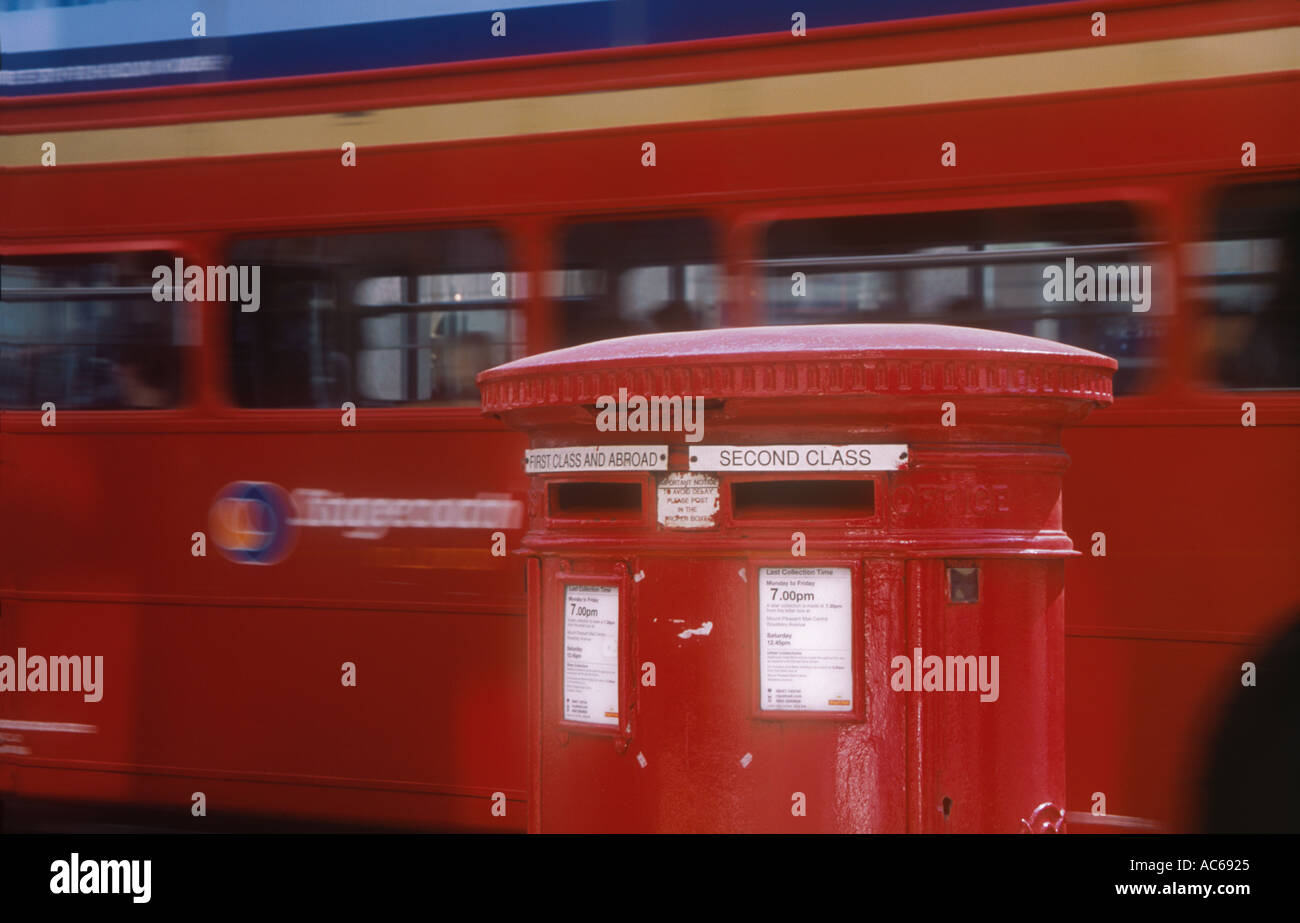 Red London Letter Box with Blurred Bus in Bakground Stock Photo - Alamy