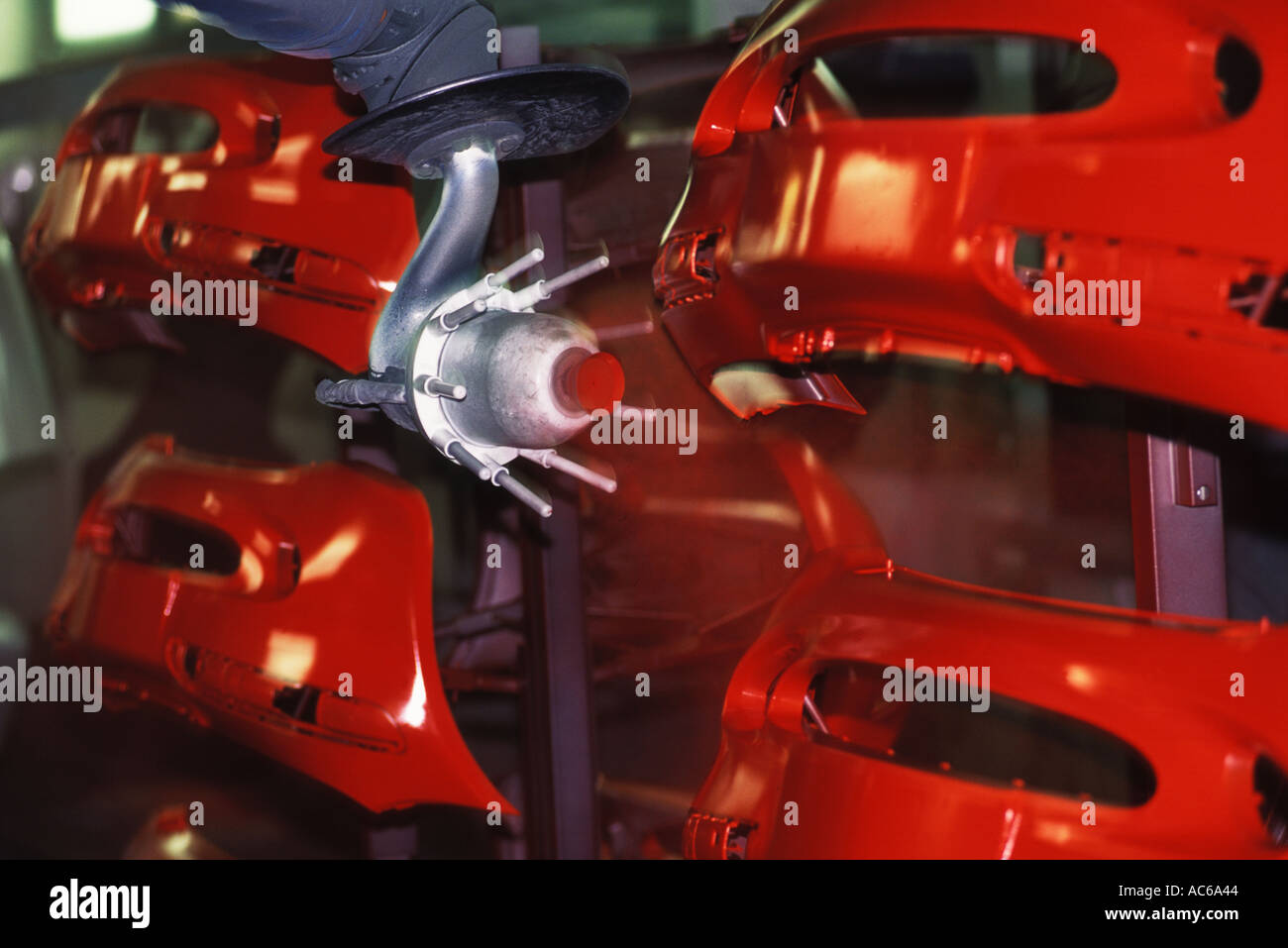 Robot paints car parts. German car assembly plant Germany 1990s circa ...