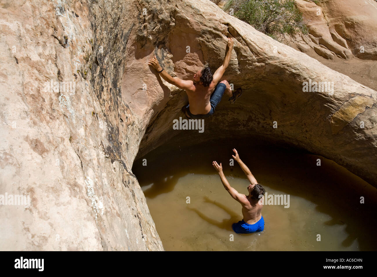 Eric Odenthal bouldering in a desert pool while Mark Howe spots in Zero ...