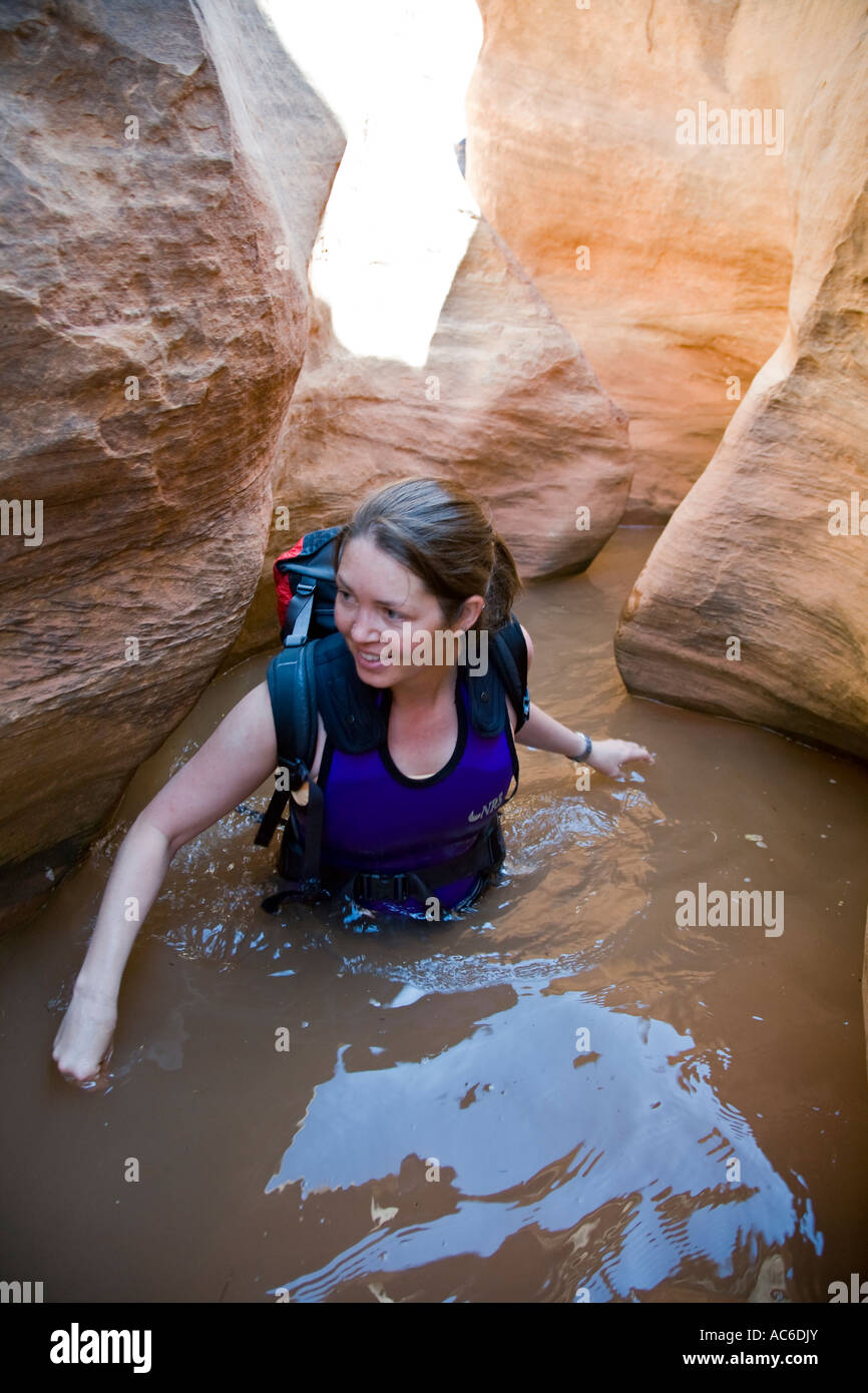 Anne Bogan wading through pool while canyoneering in Cheesebox Canyon ...