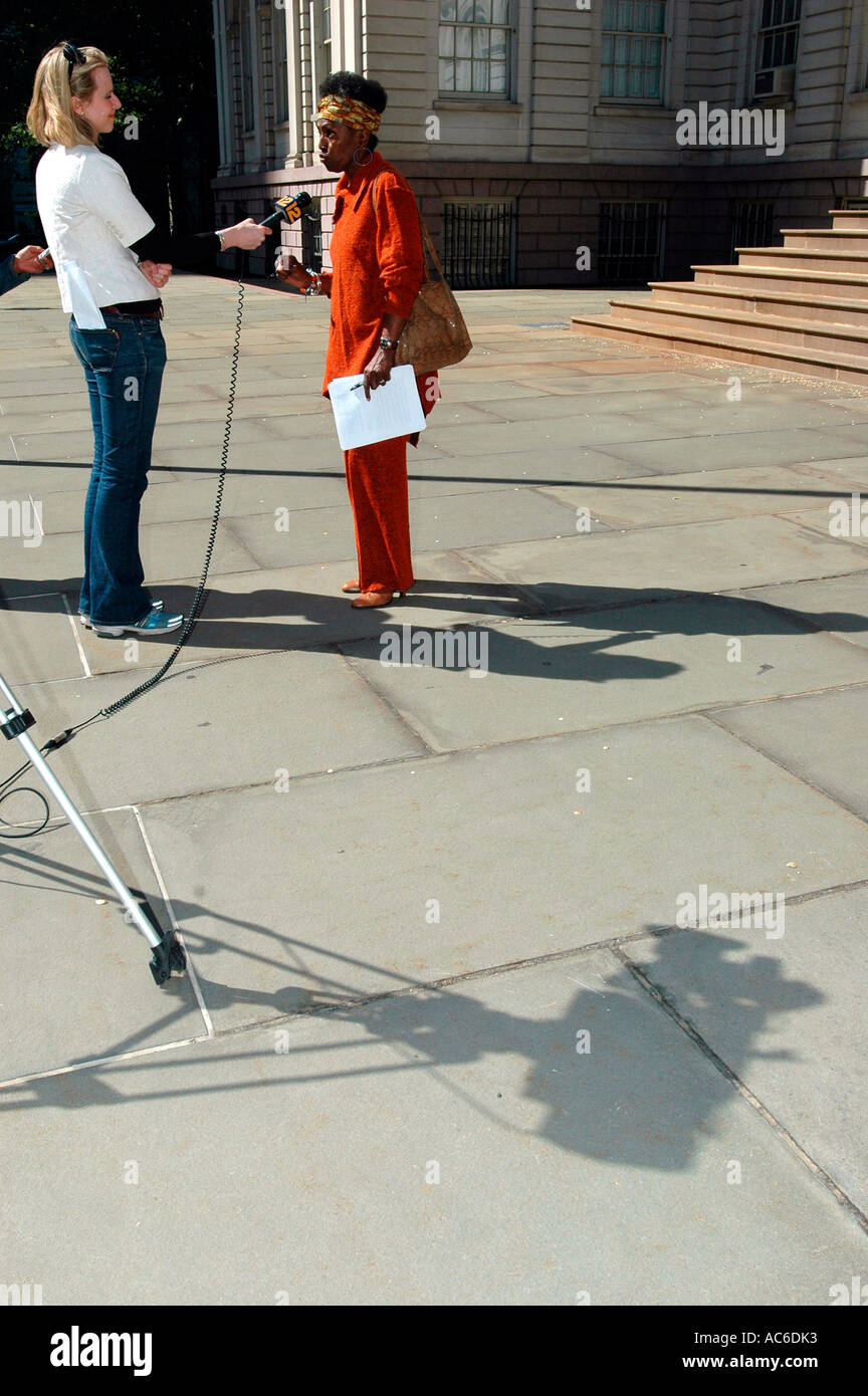 Female television reporter interviews female african american activist ...