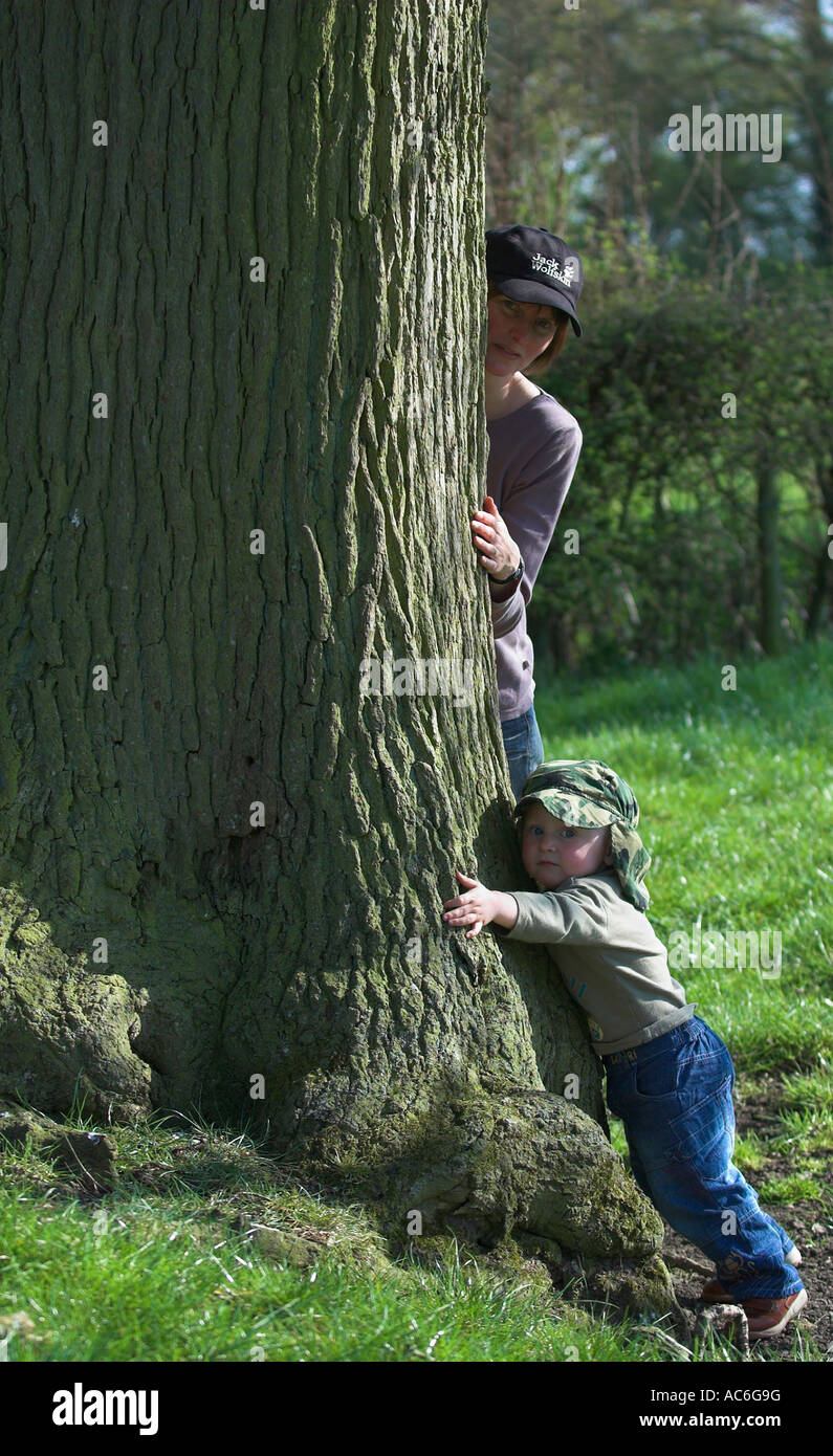 Mother and child hugging oak tree Quercus rober Stock Photo - Alamy