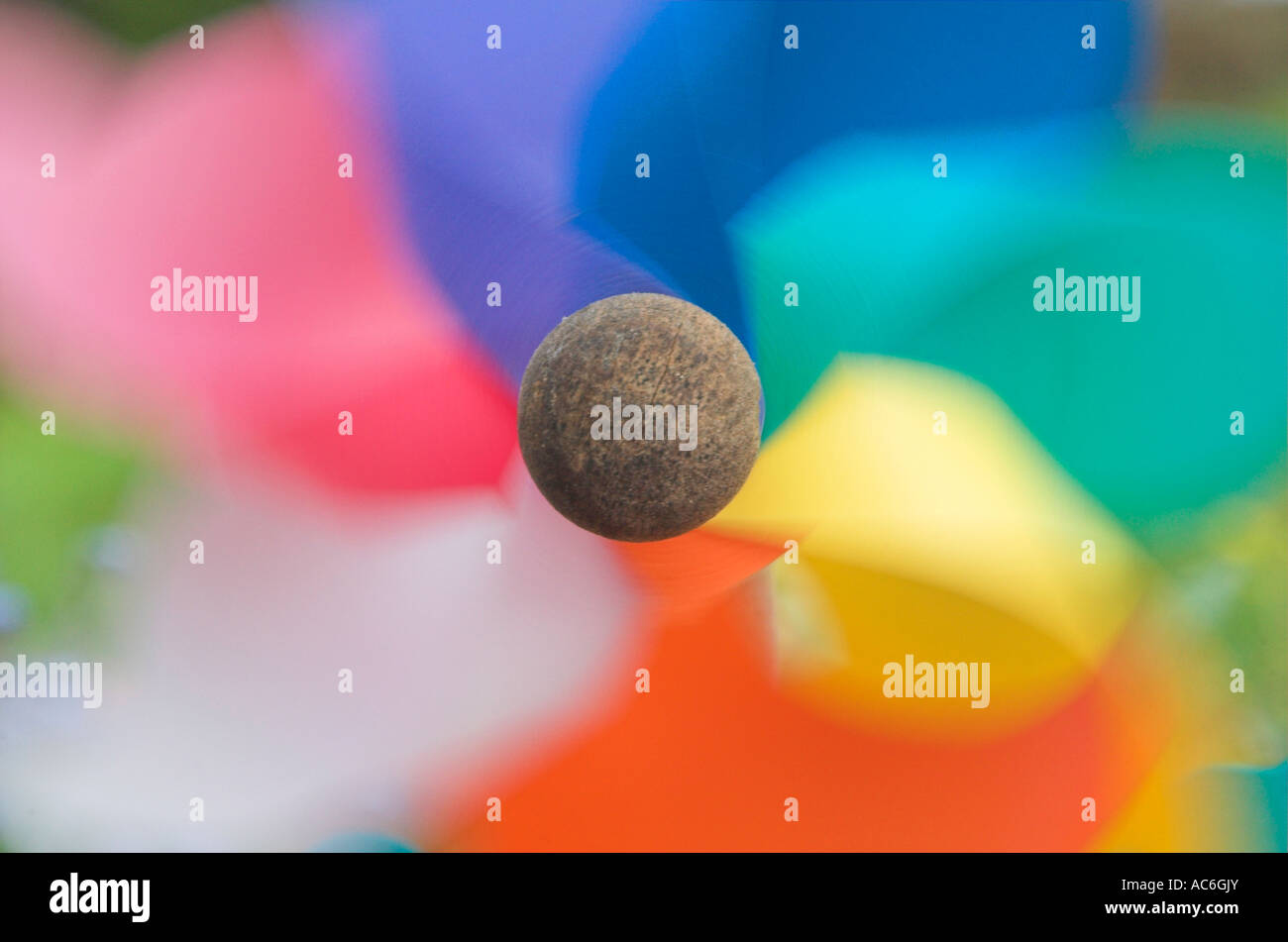 Multi coloured child s windmill spinning in the wind Stock Photo - Alamy