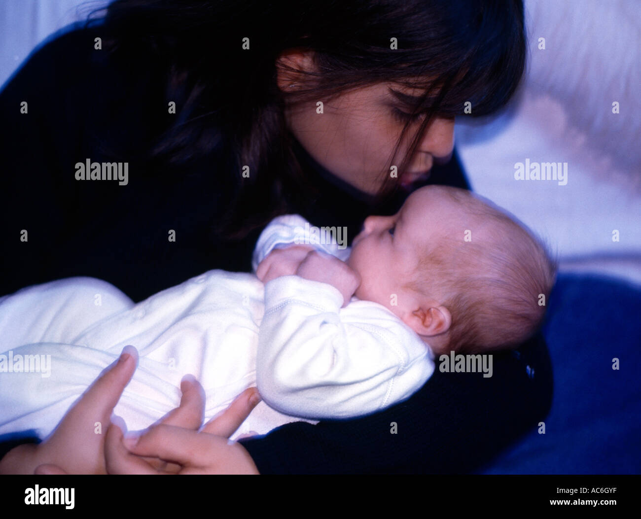 Child with Baby Kissing Baby's Forehead Stock Photo - Alamy