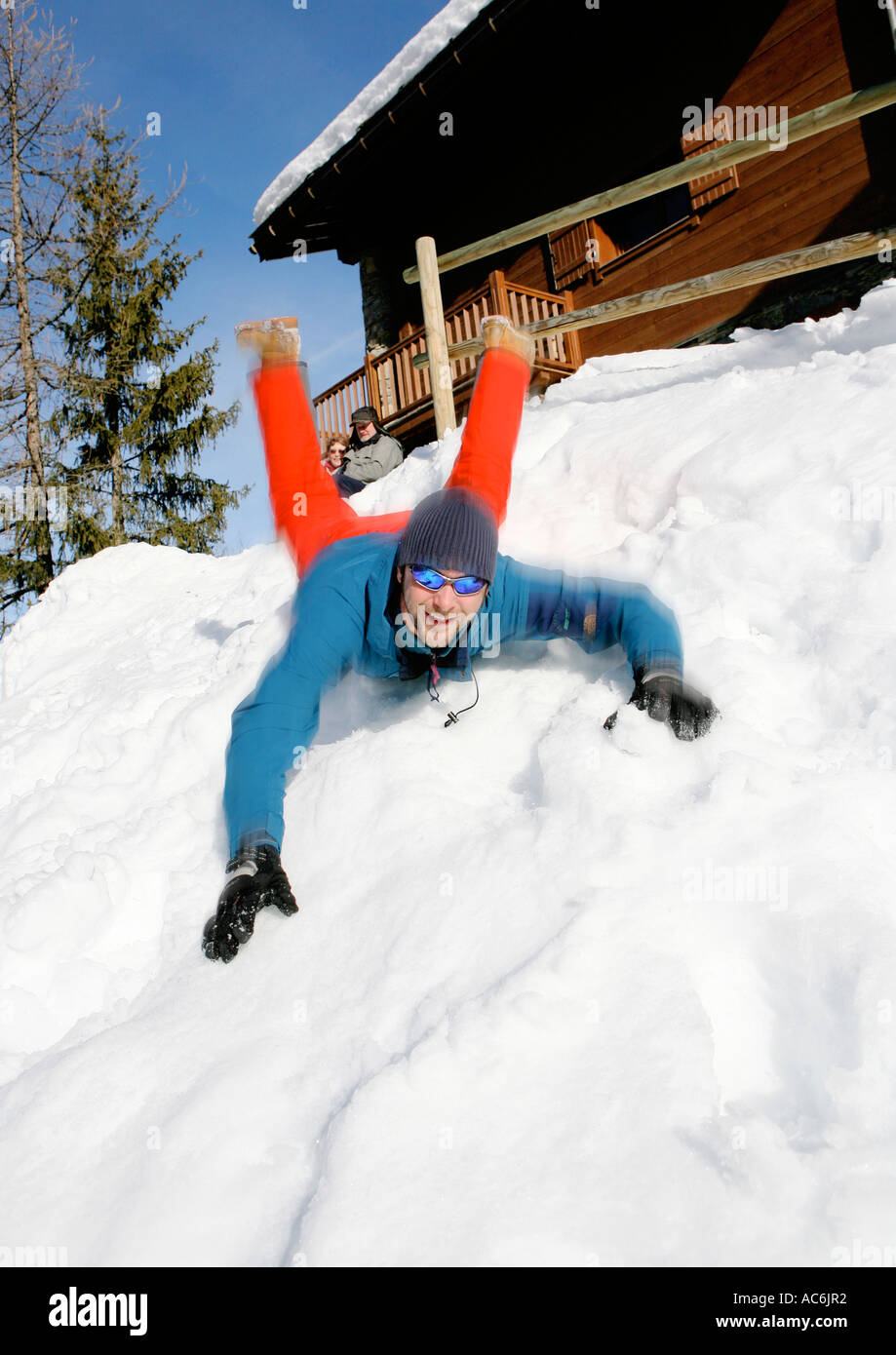 man sliding down snow slope Stock Photo - Alamy