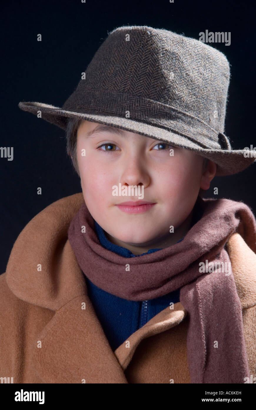 Young boy in warm overcoat wearing a scarf and fedora hat Stock Photo ...