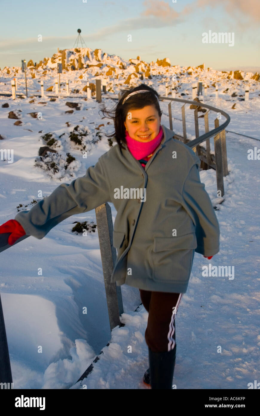 An 11 year old girl well rugged up against the cold on the peak of ...