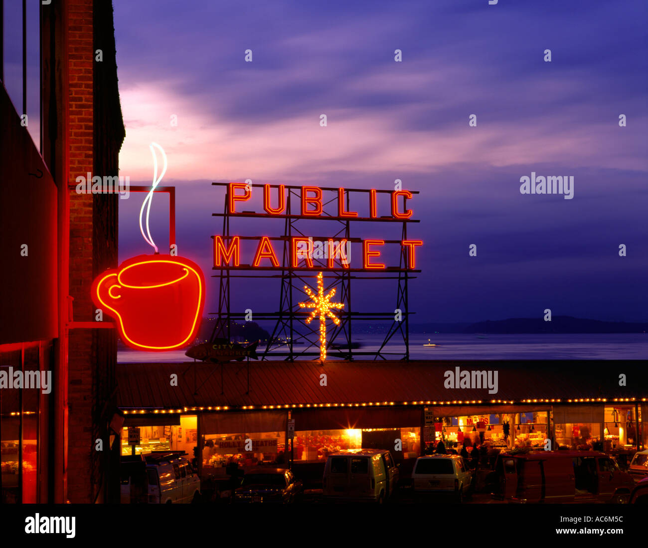 Seattle WA: Neon coffee market signs at dusk above the Pike Street ...