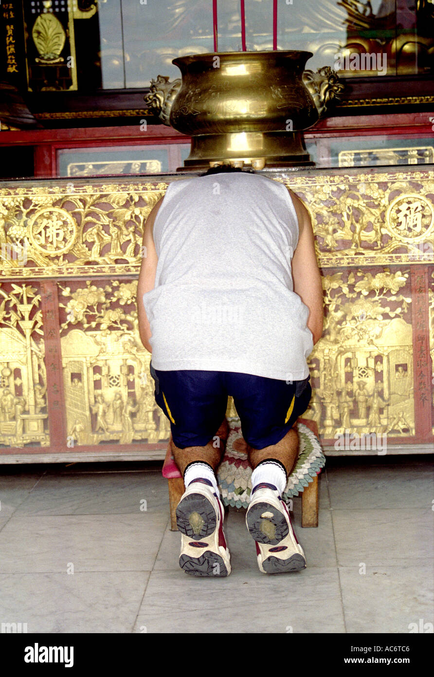 KNEELING FOR PRAYER RELIGIOUS TEMPLE PENANG ISLAND MALAYSIA BAPN676 ...