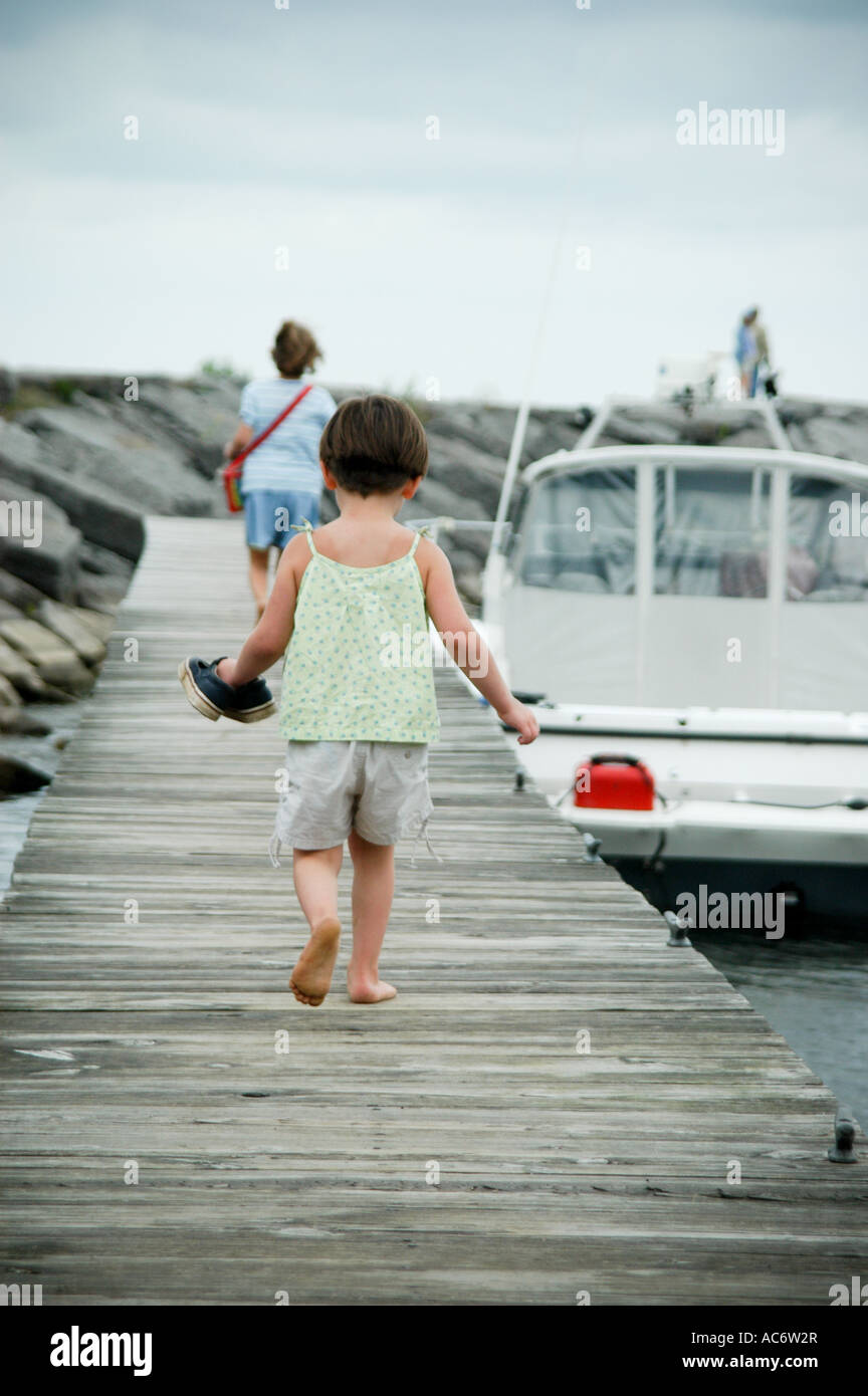 Kids walking the dock Stock Photo - Alamy