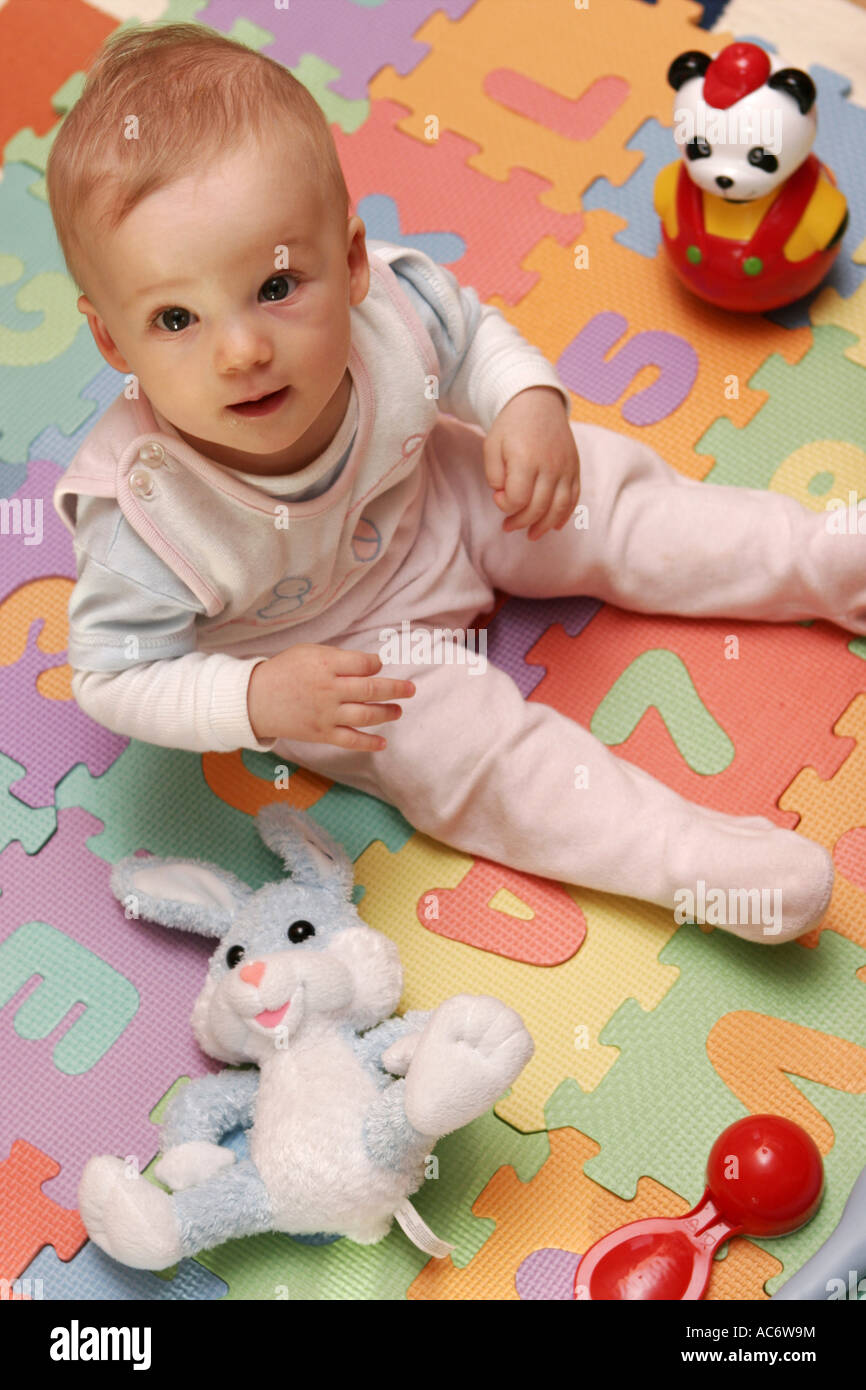 Baby playing on the floor Stock Photo - Alamy