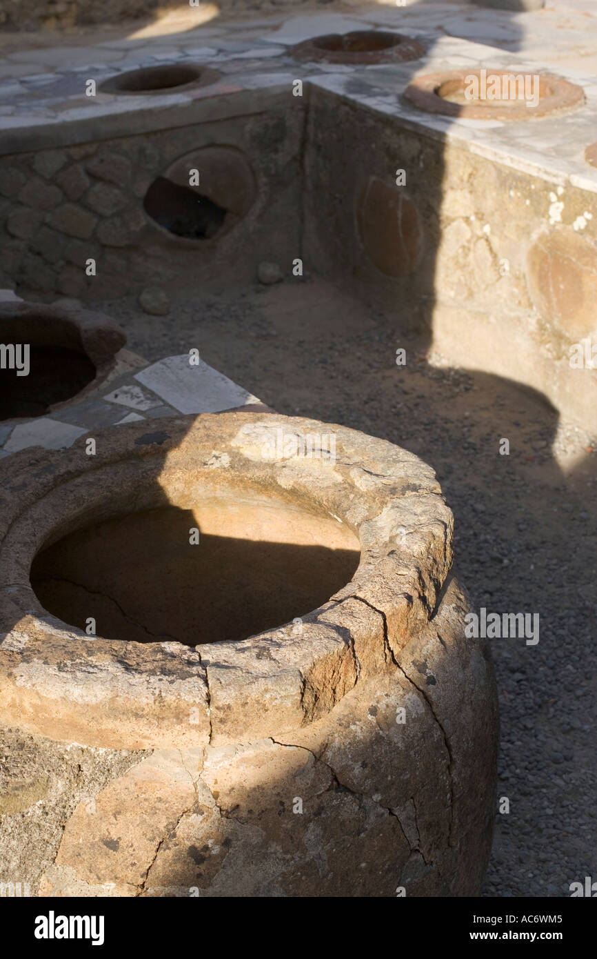 clay pot and marble counter in the Grande Taberna in herculaneum italy ...