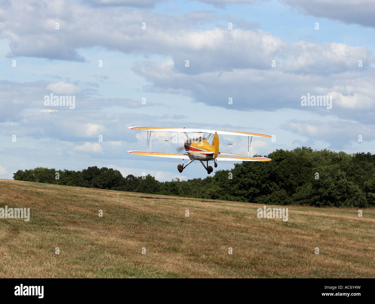 A Great Lakes Traner flying across a grass field Stock Photo - Alamy